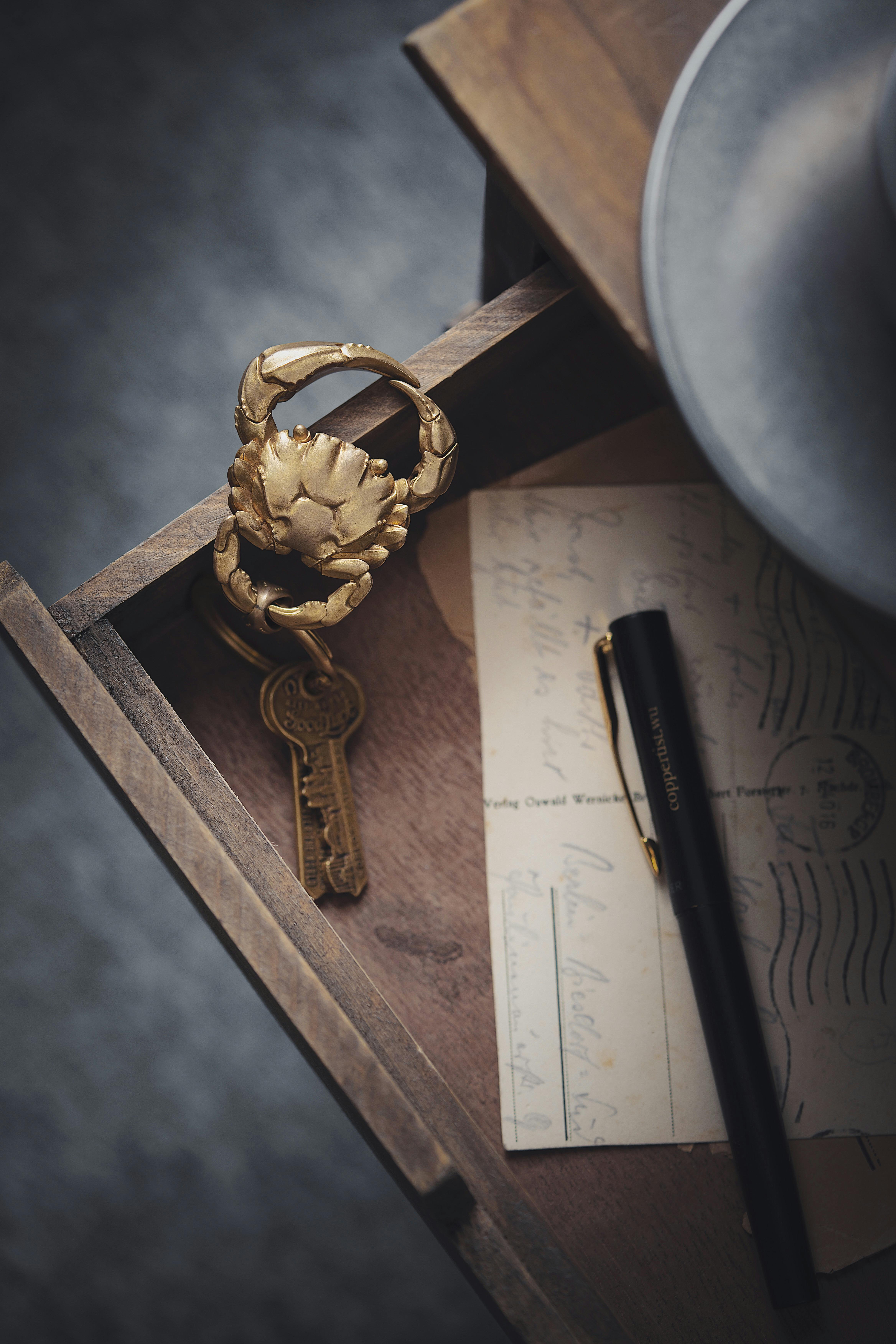 Golden Keychain and Keys in Drawer · Free Stock Photo