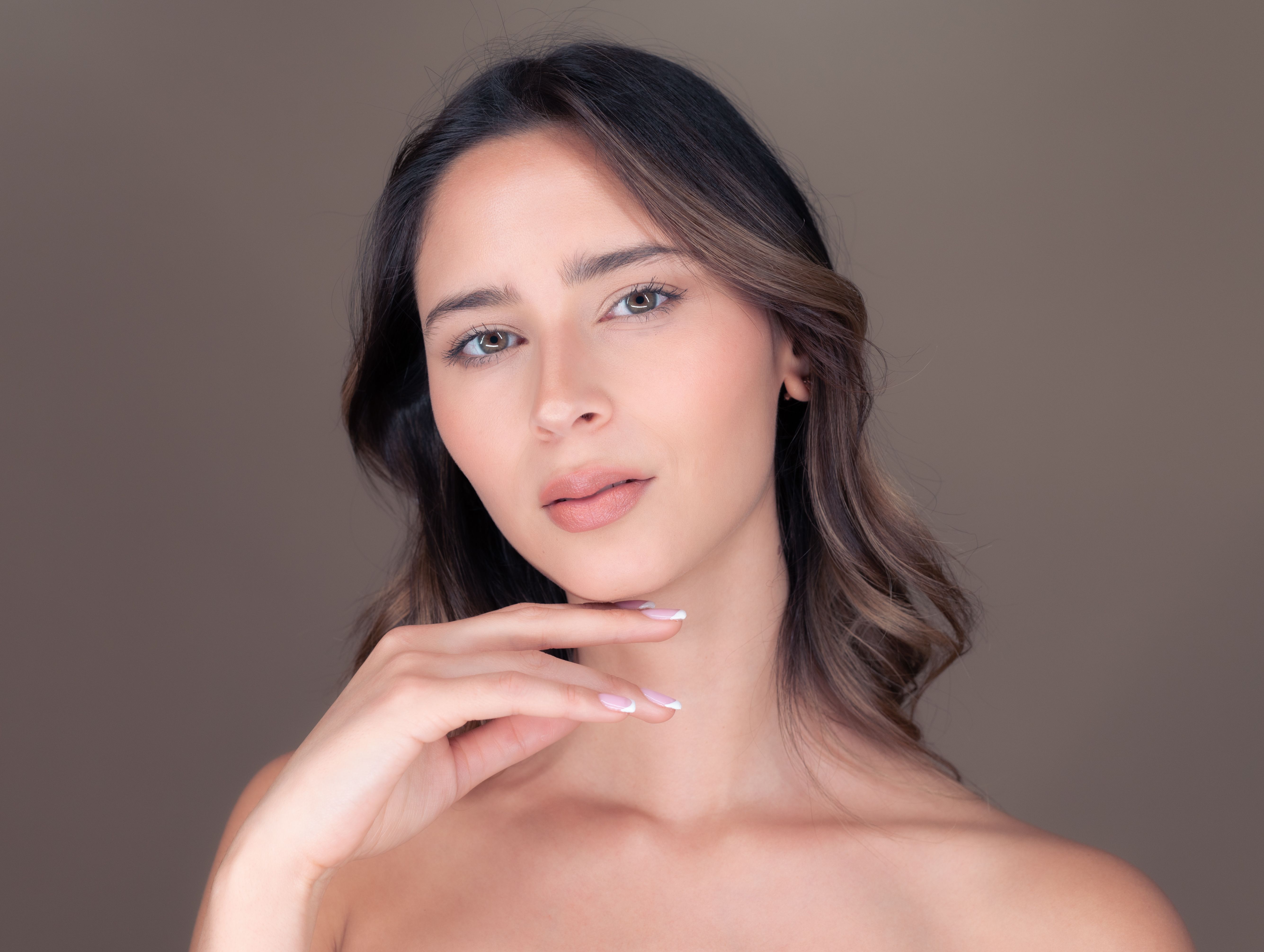 Woman Face on Brown Background · Free Stock Photo