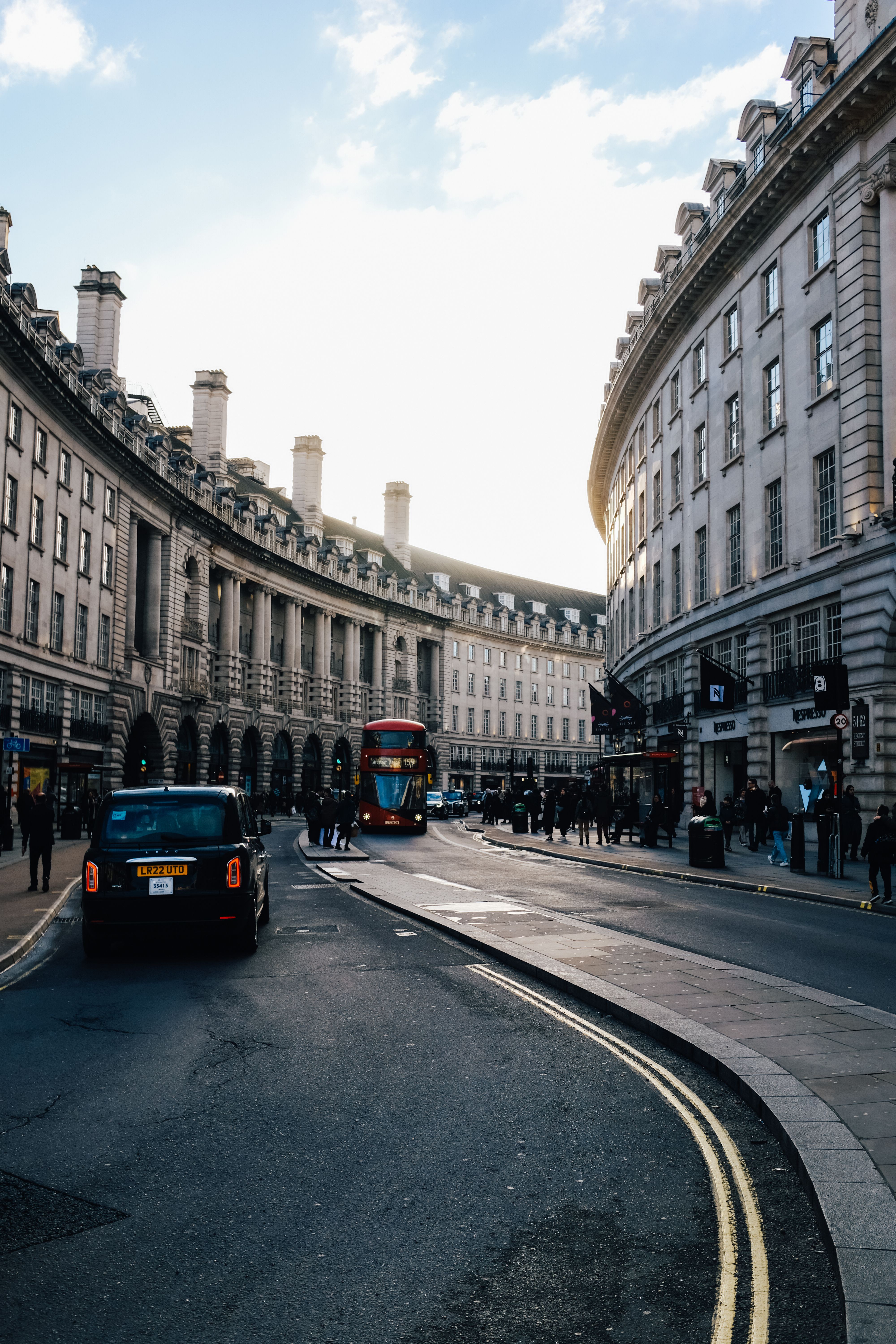 Double-deck Bus Parked Surrounded by Buildings · Free Stock Photo