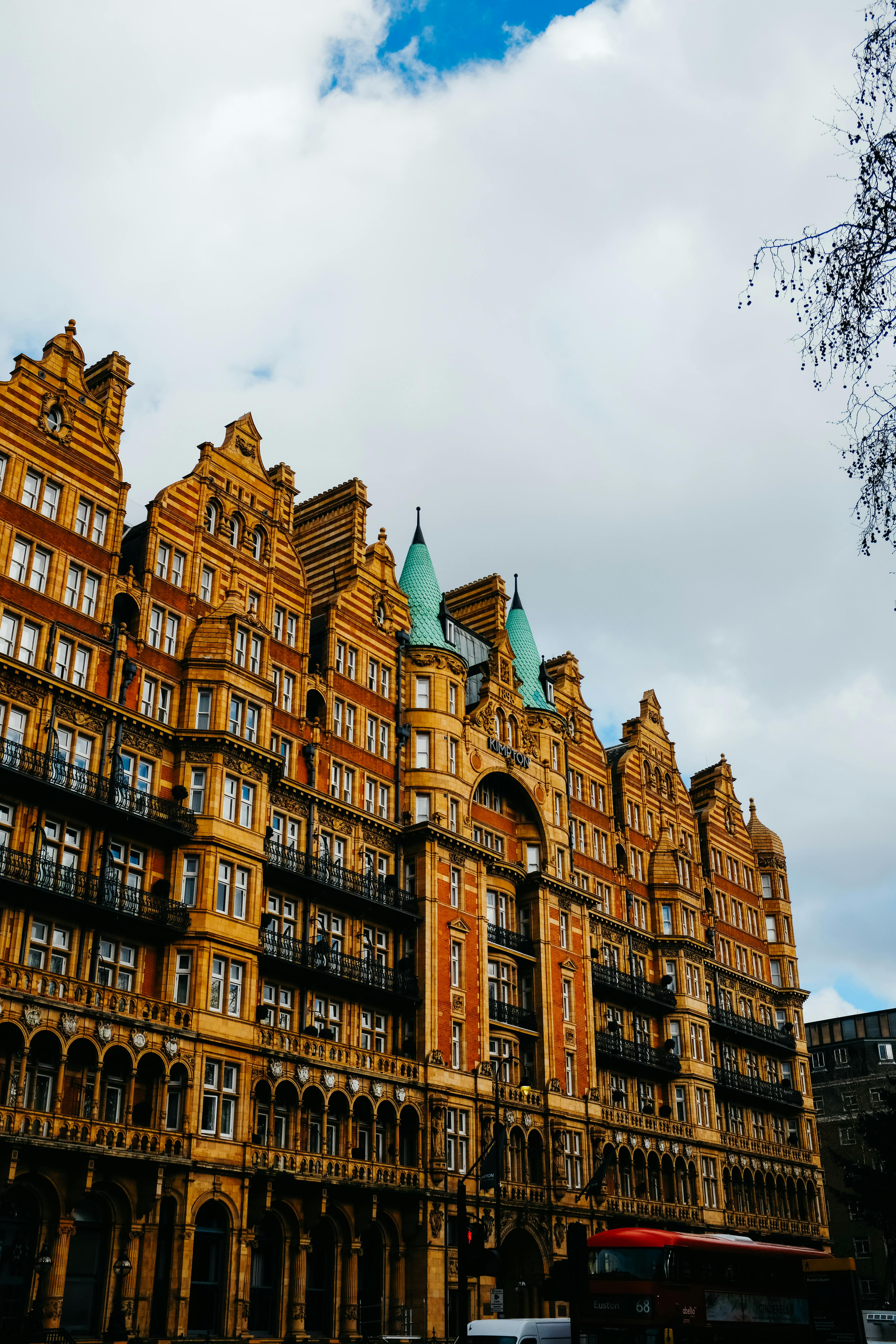 Traditional Old Apartment House Facade against Blue Sky · Free Stock Photo