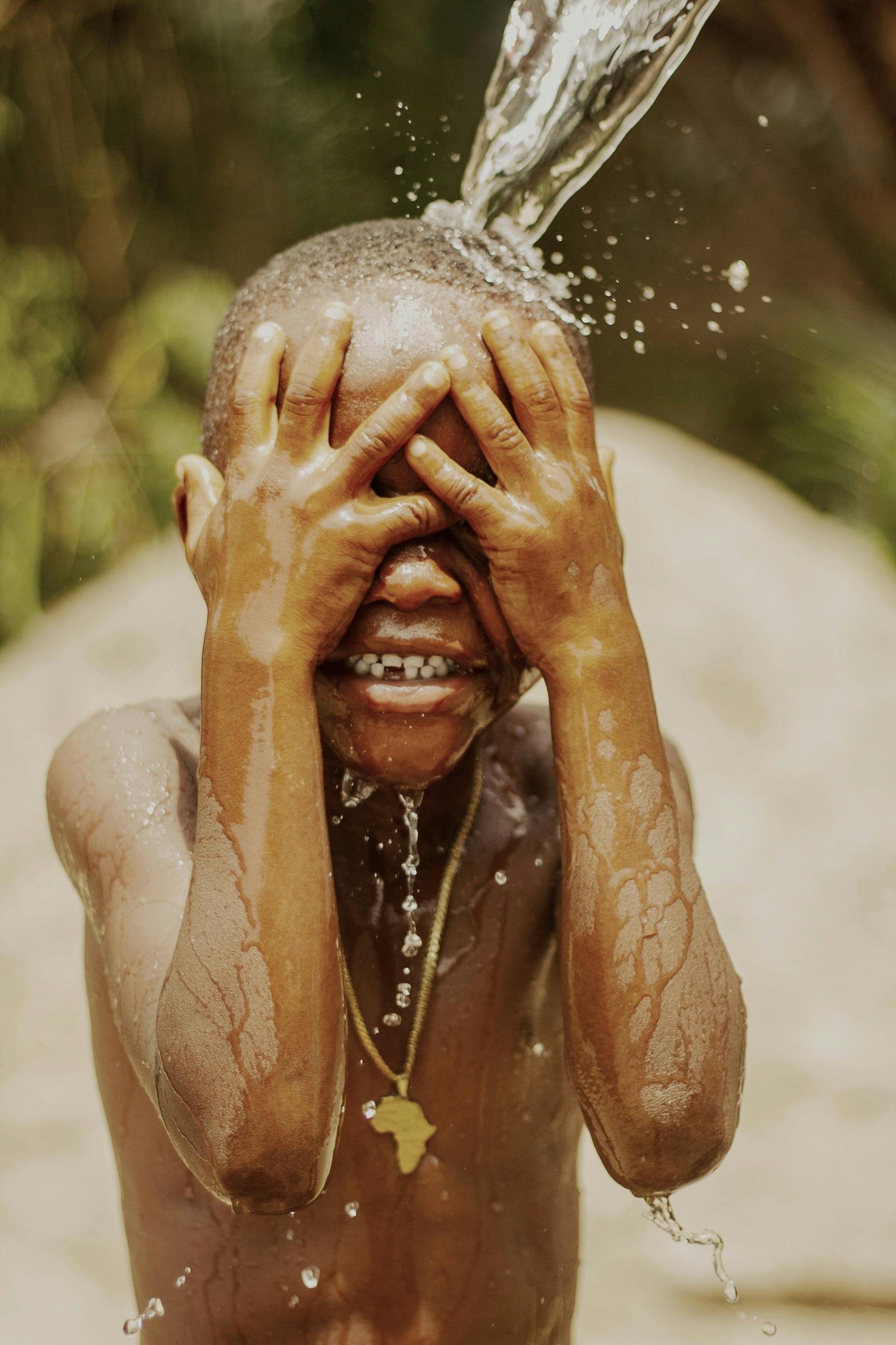 Young Boy Covering Face with Hands being Splashed with Water · Free ...