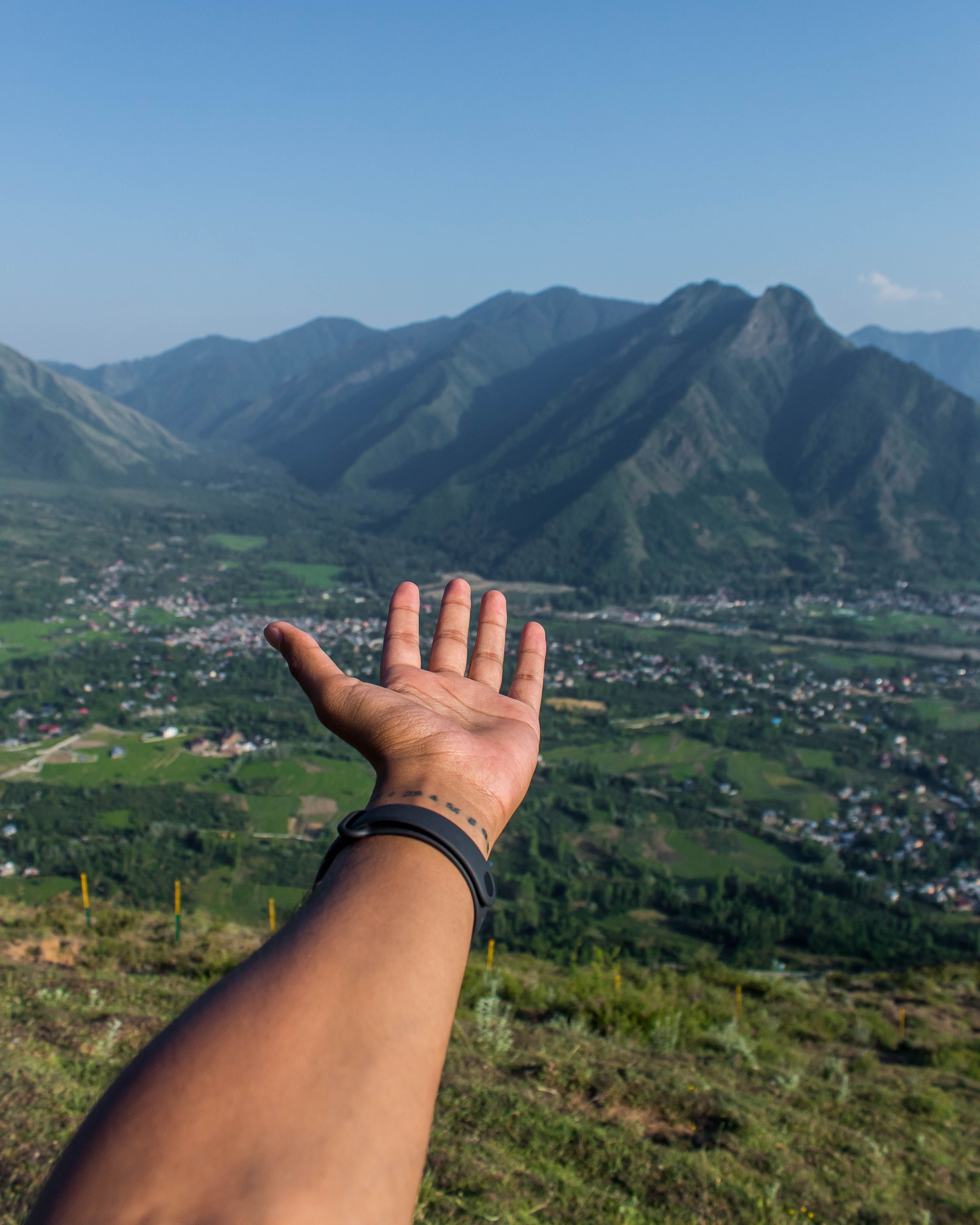 Mans Hand in a Mountain Valley · Free Stock Photo