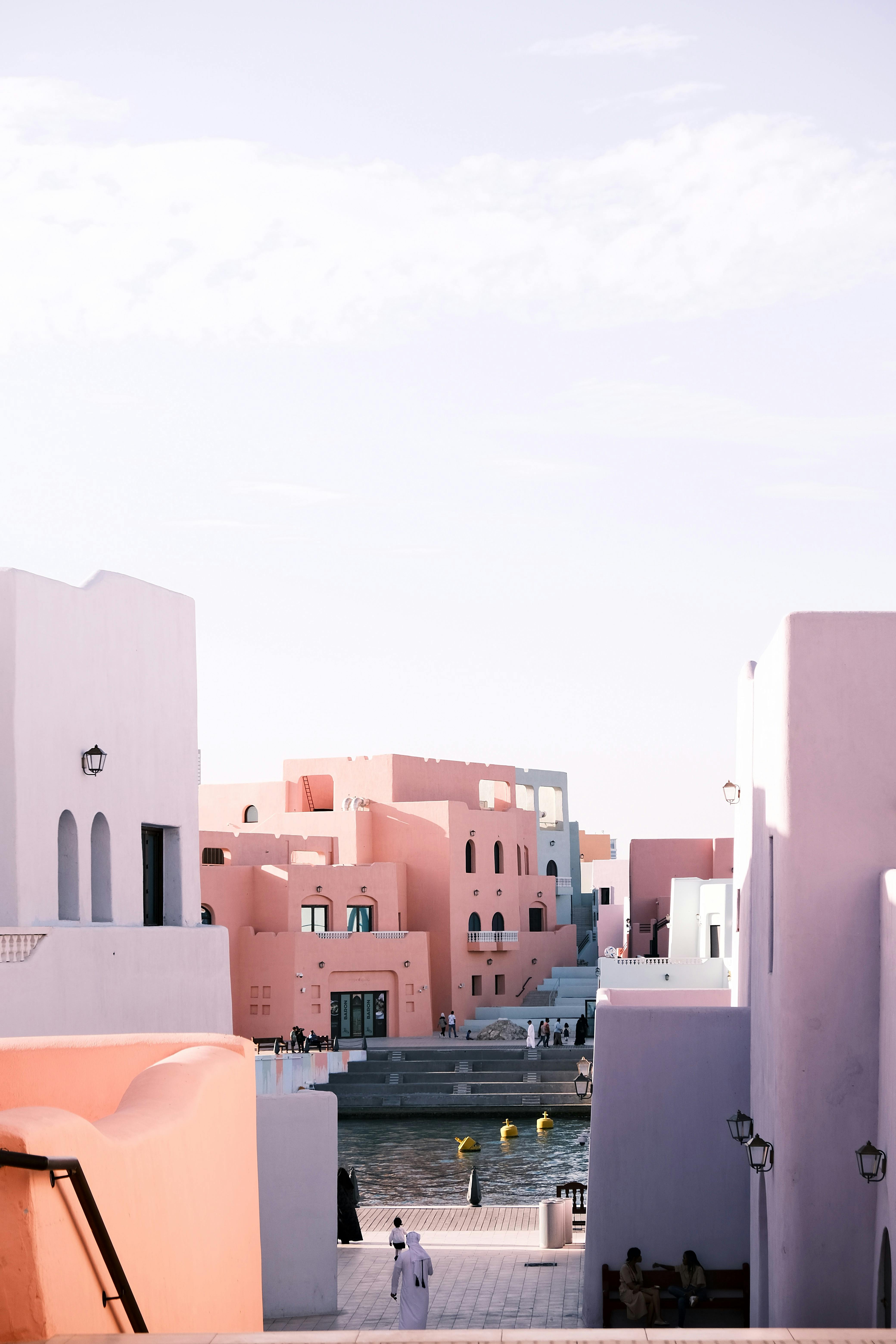 Pastel Colored Buildings under Cloudy Sky · Free Stock Photo