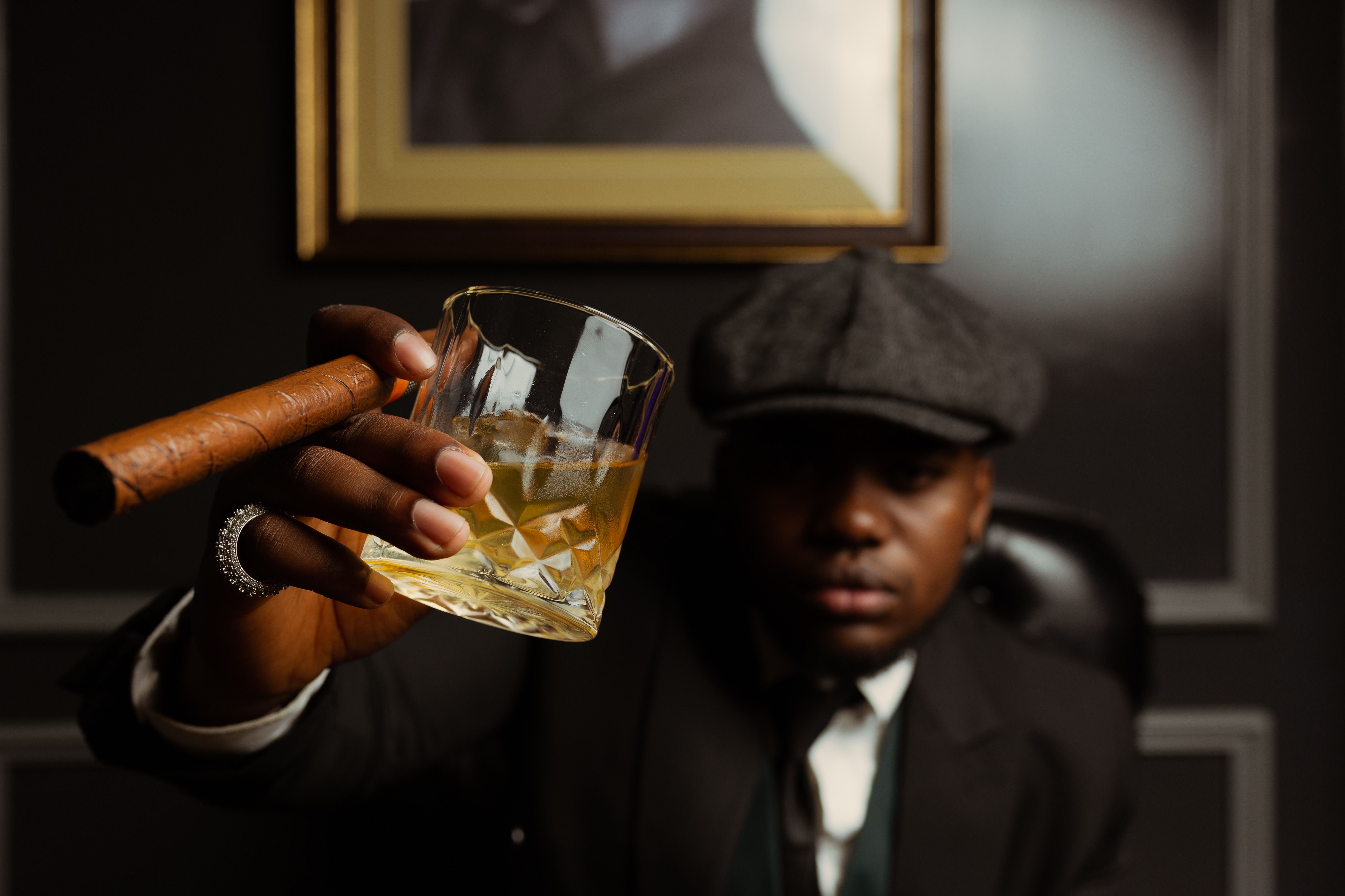Man in a Peaked Cap Drinking Whisky and Smoking a Cigar · Free Stock Photo