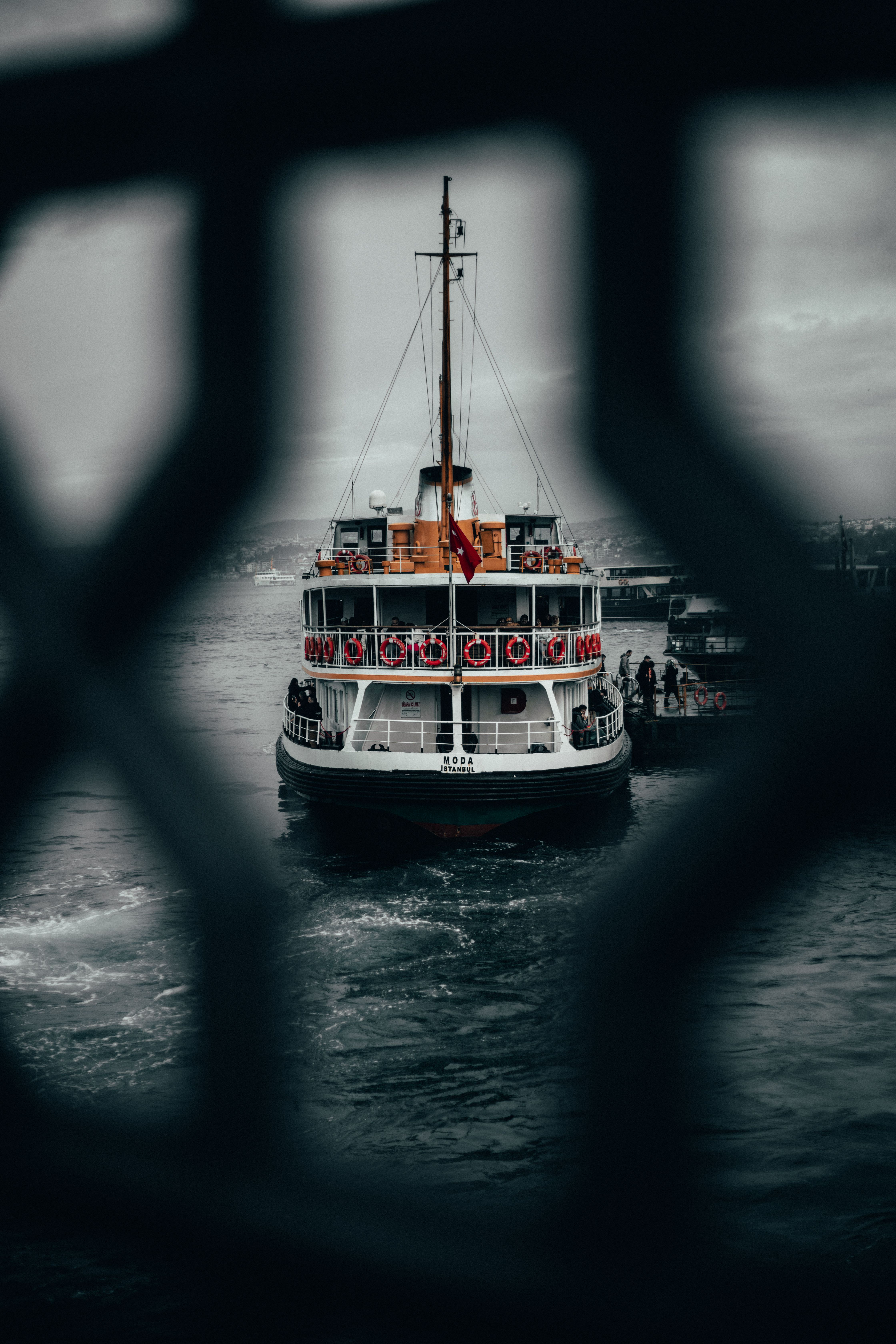 Majestic Ship on Sea Behind Harbor Fence · Free Stock Photo