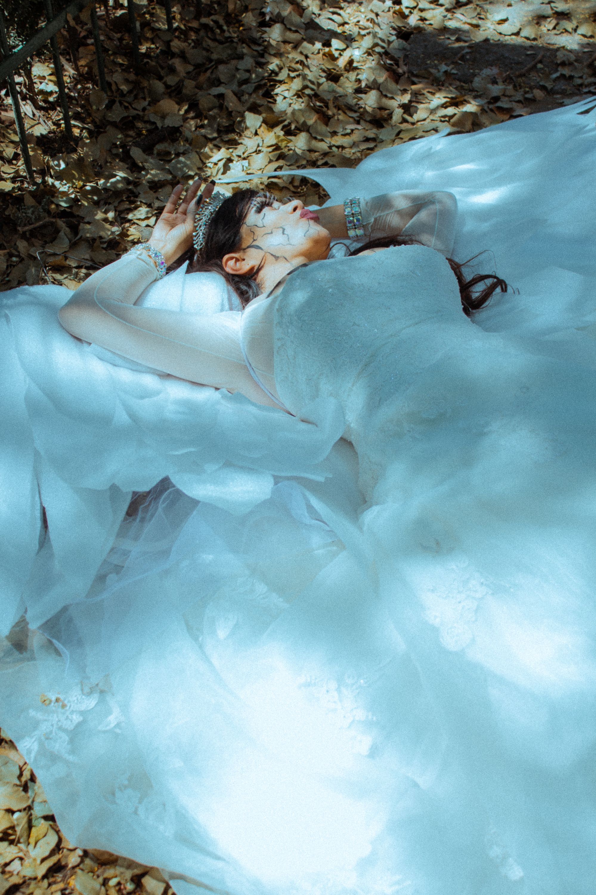 A Woman in a Wedding Dress Lying on the Ground · Free Stock Photo