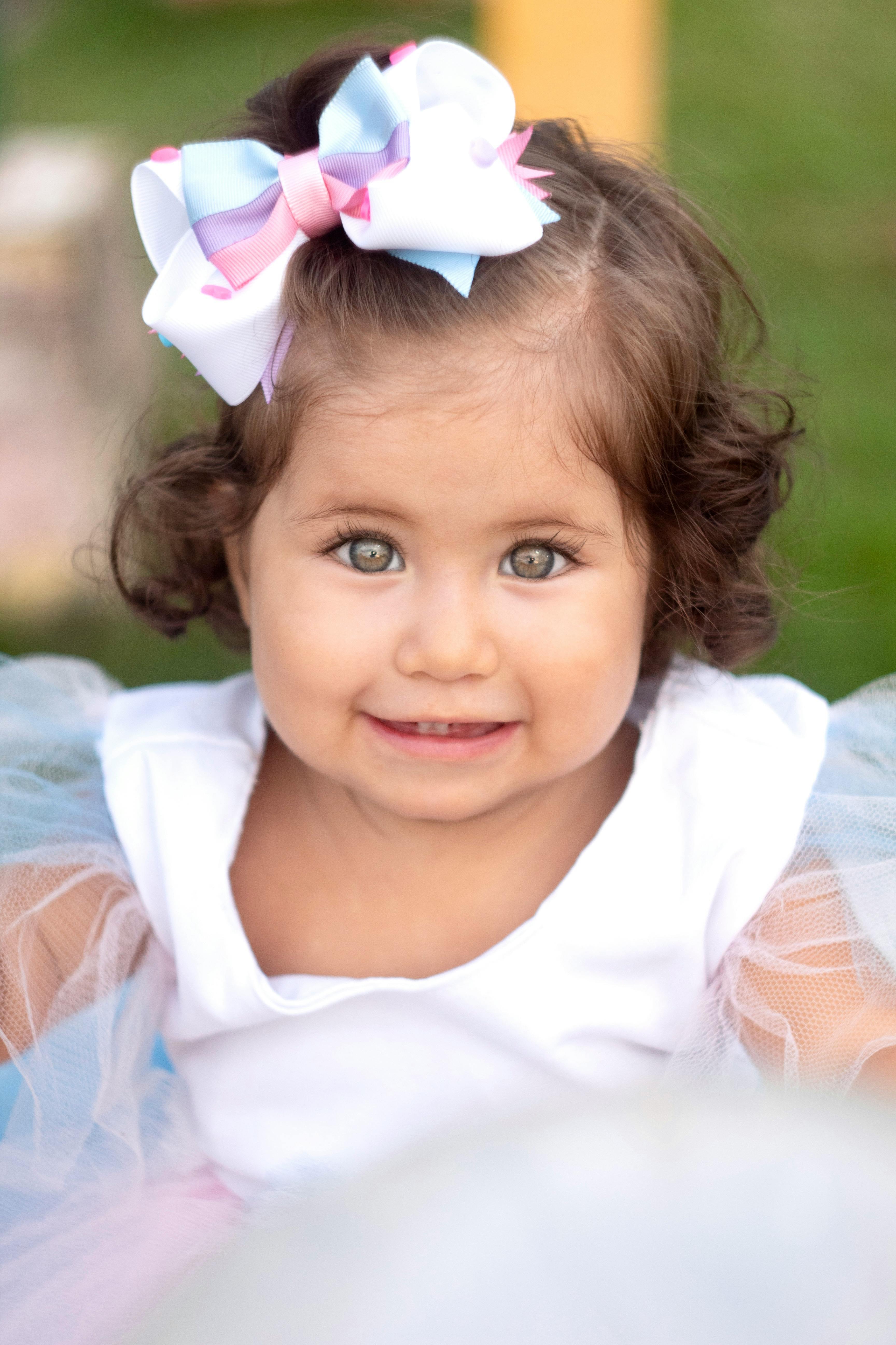 Little Girl Sitting at a Table and Playing · Free Stock Photo