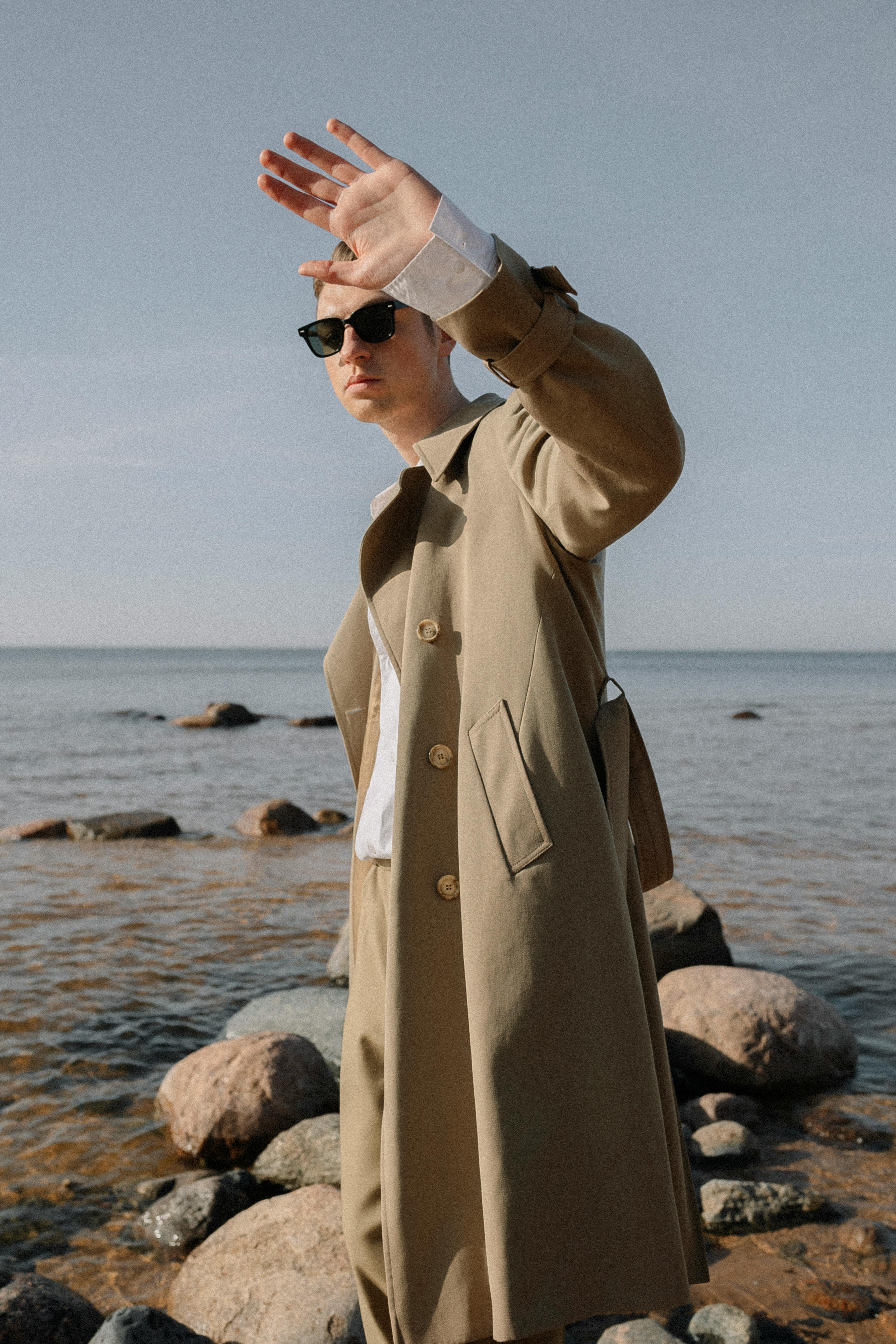 Man Protecting Face with Hand from Sun · Free Stock Photo
