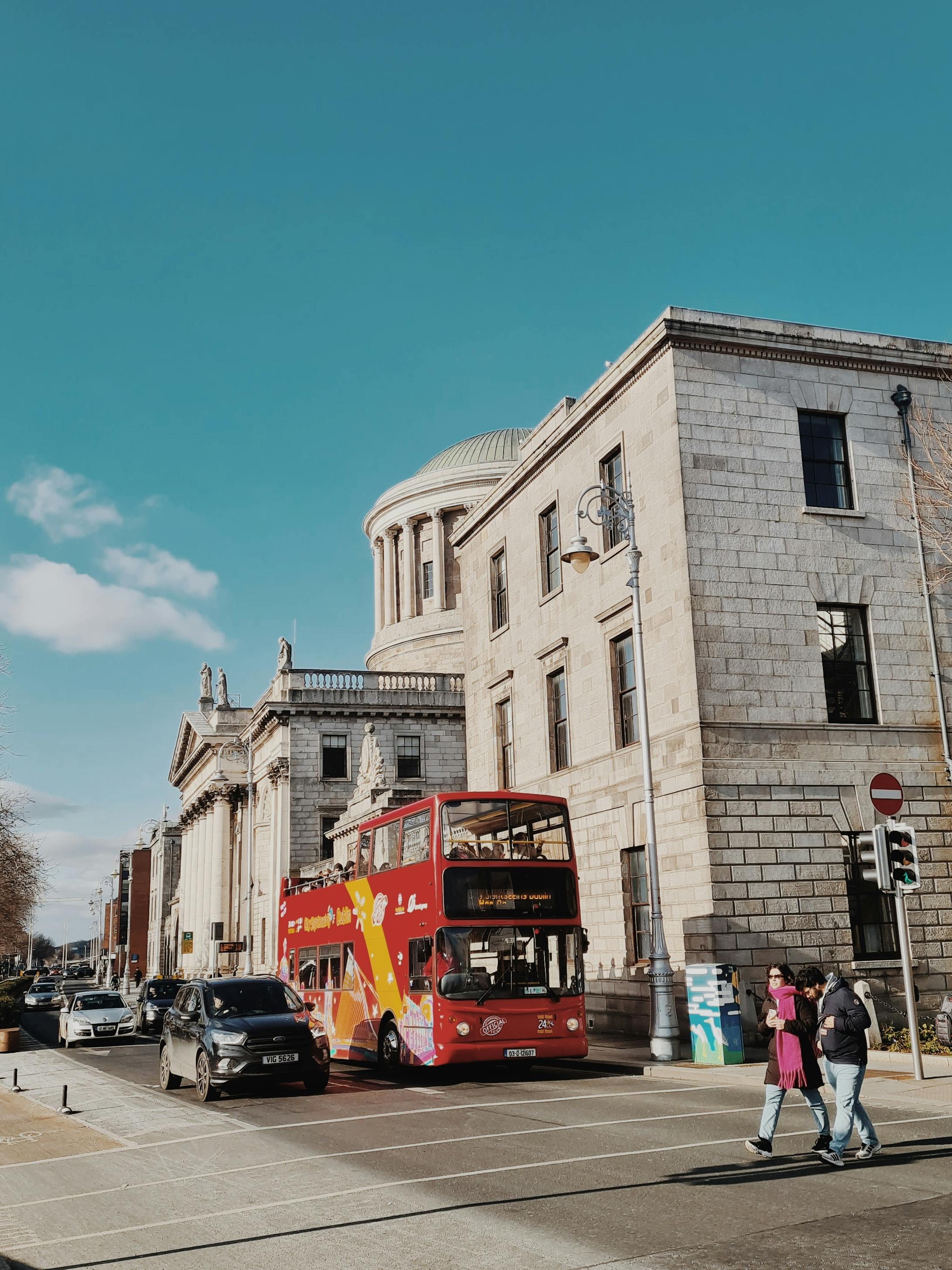 A Red Hop on Hop off Bus in front of the Four Courts, Dublin, Ireland ...