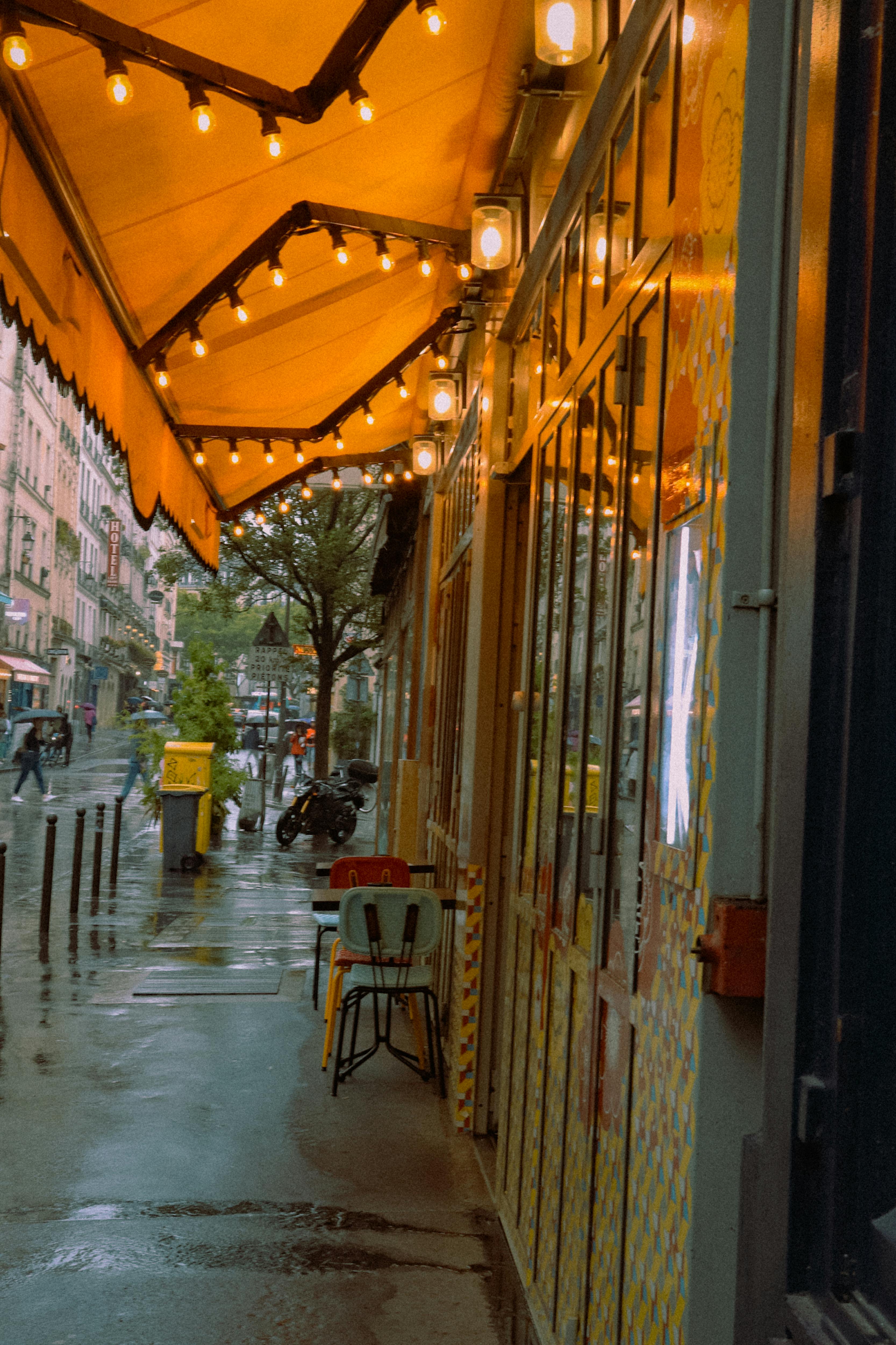 A street with yellow lights and awnings · Free Stock Photo