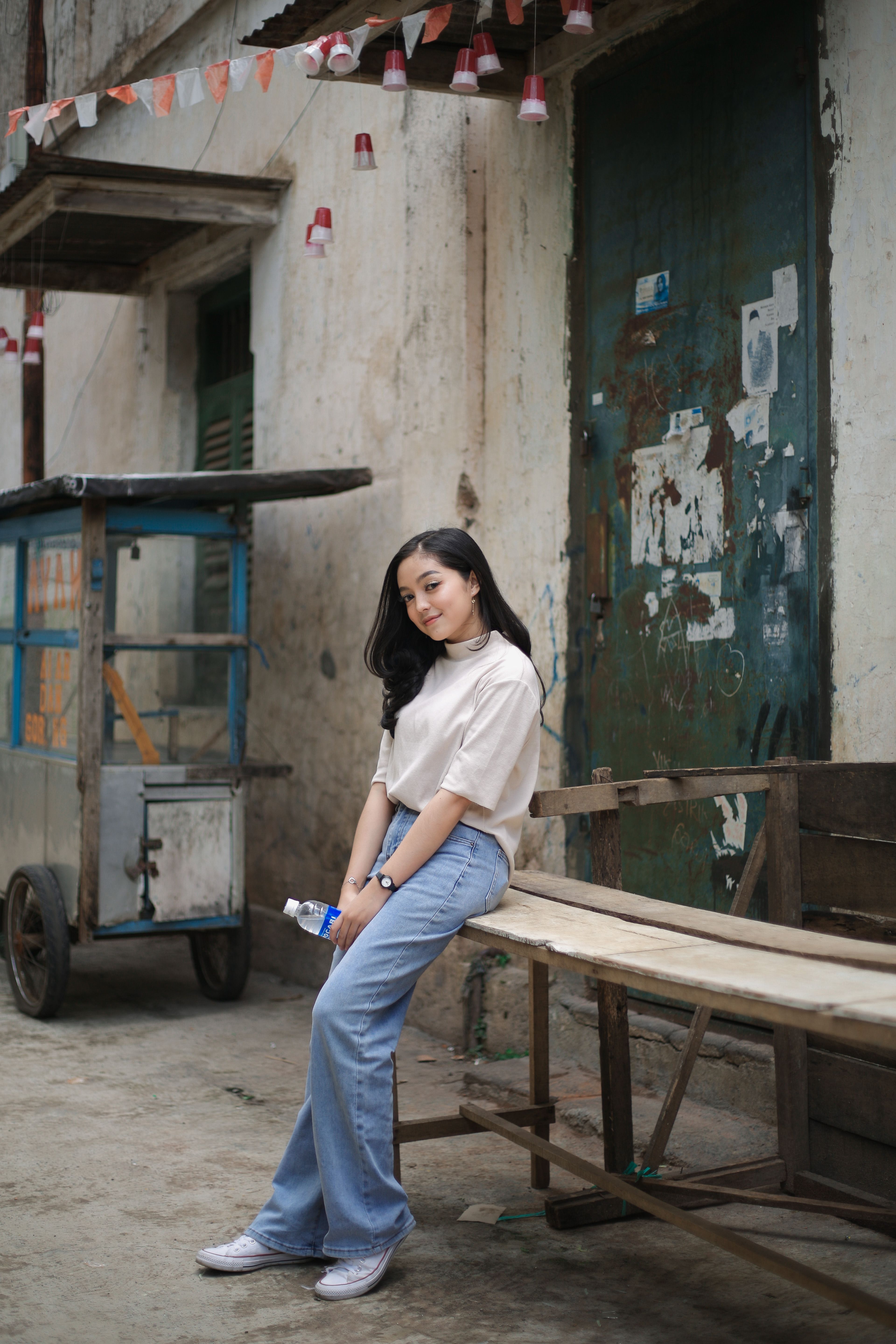 Woman Smiling and Leaning on Bench · Free Stock Photo