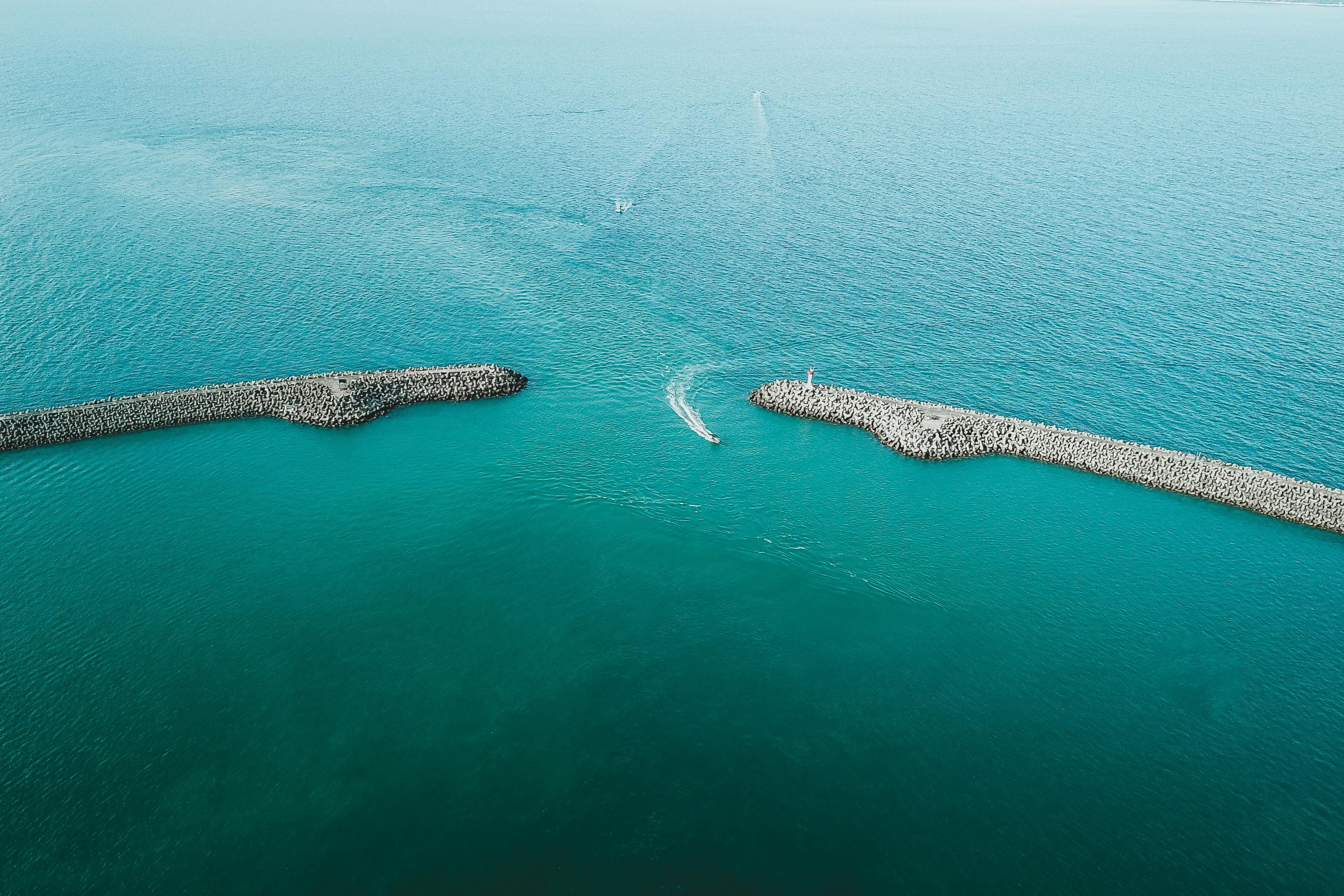Aerial View of Two Promontories and a Ship · Free Stock Photo