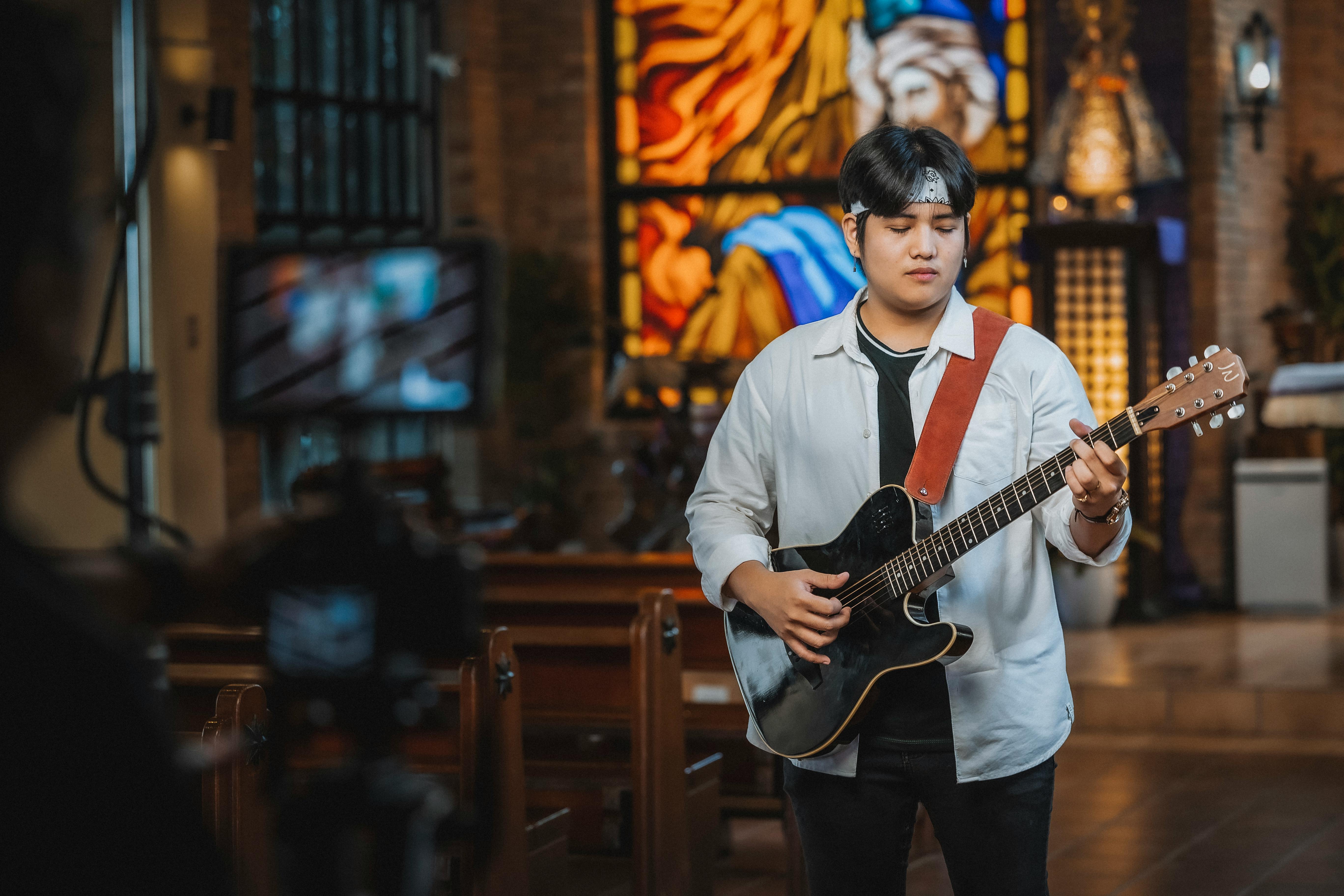 Man Playing the Electric Guitar and Filming a Music Video in a Church ...