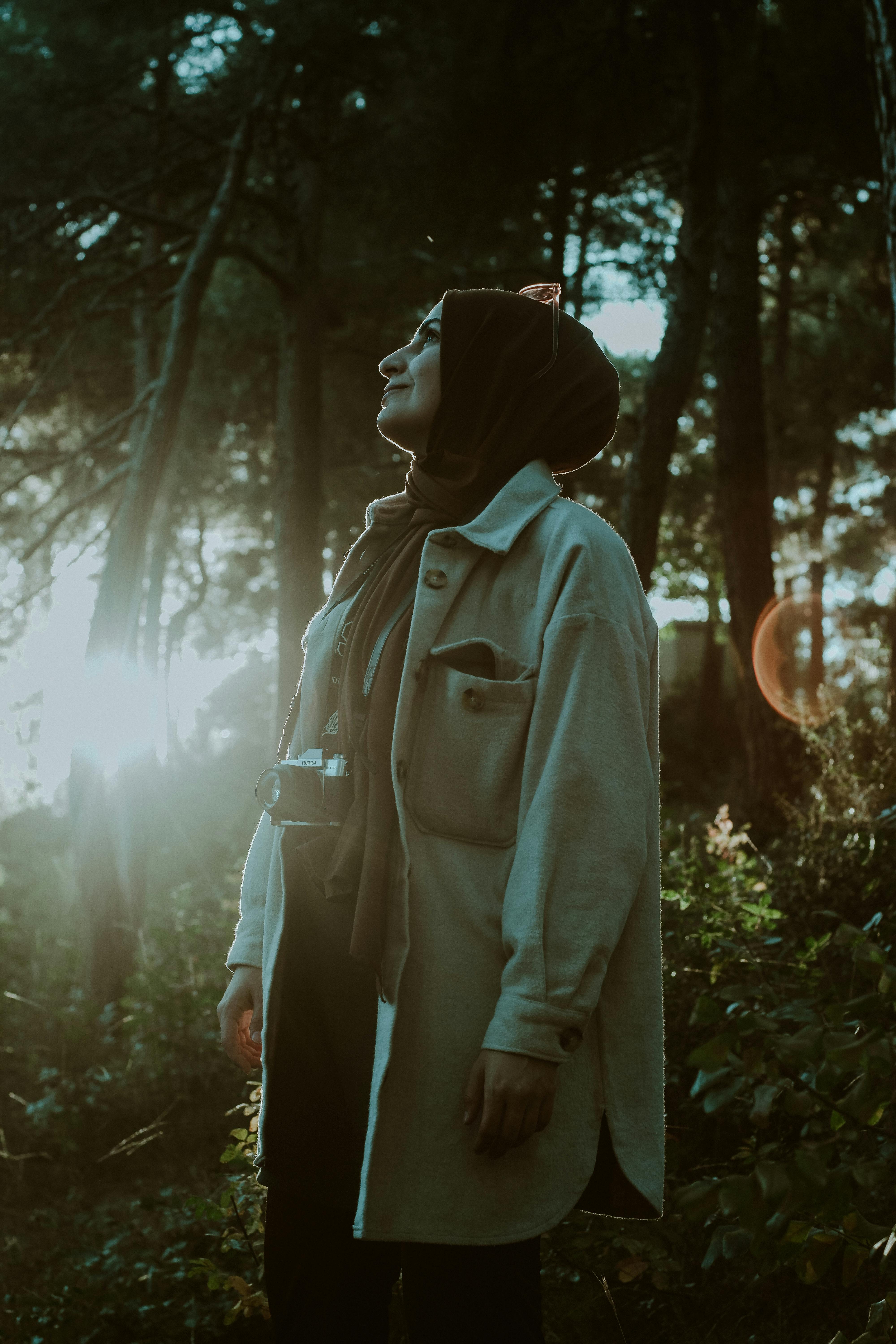 Woman Standing in a Forest at Sunset · Free Stock Photo