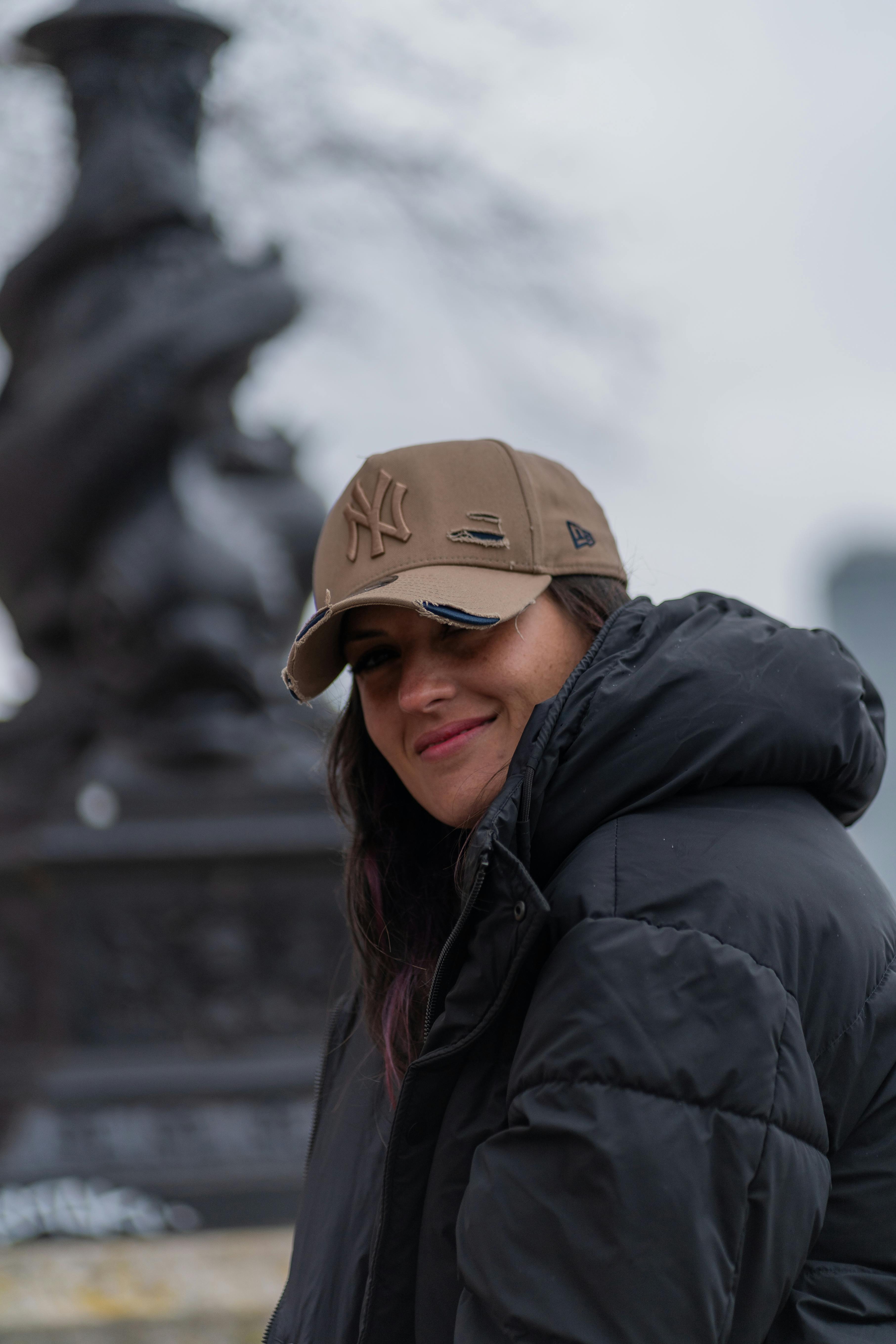 A Woman on the Bridge Wearing Cap · Free Stock Photo