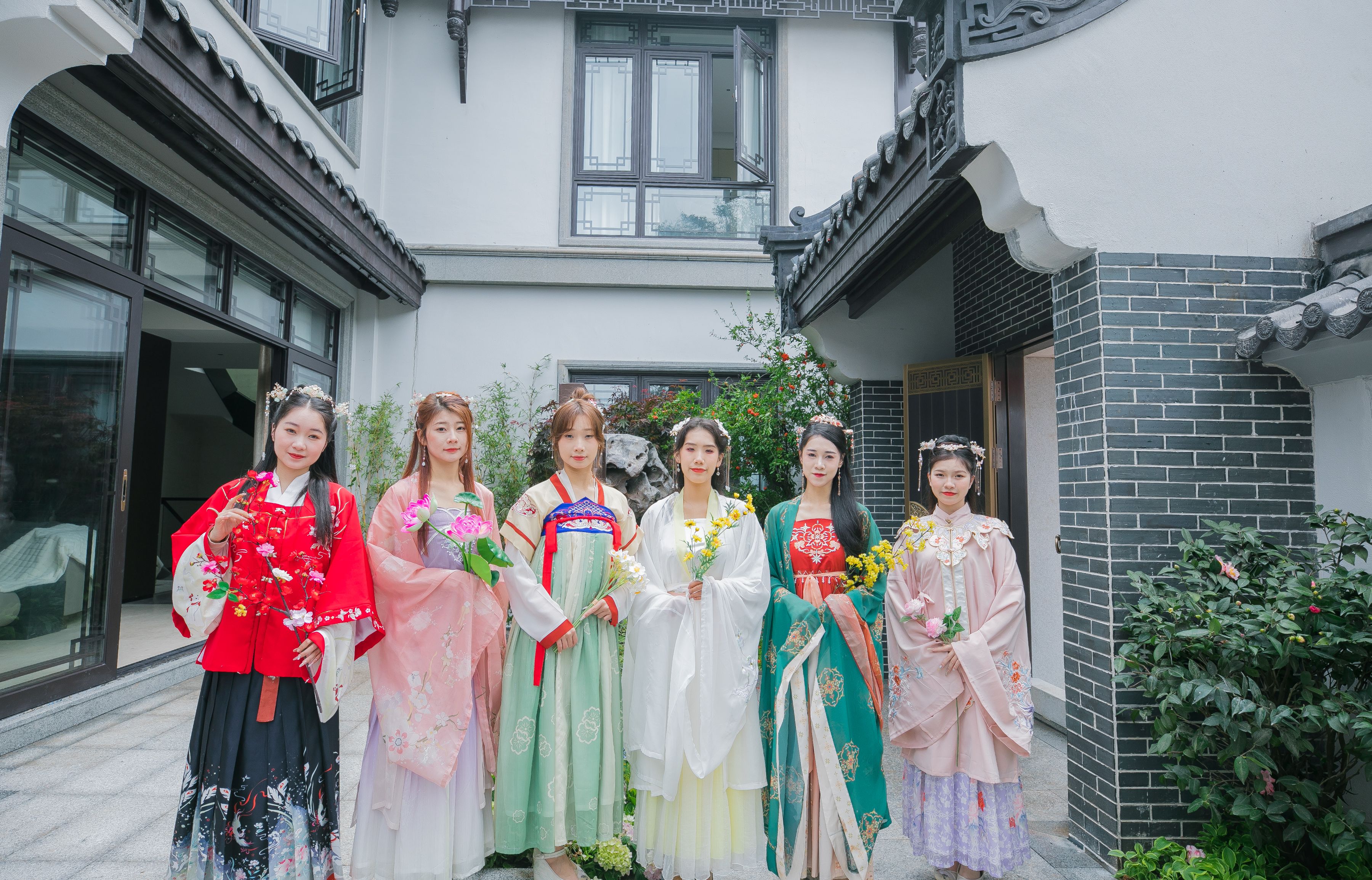 A Traditional Family Posing in front of a House · Free Stock Photo
