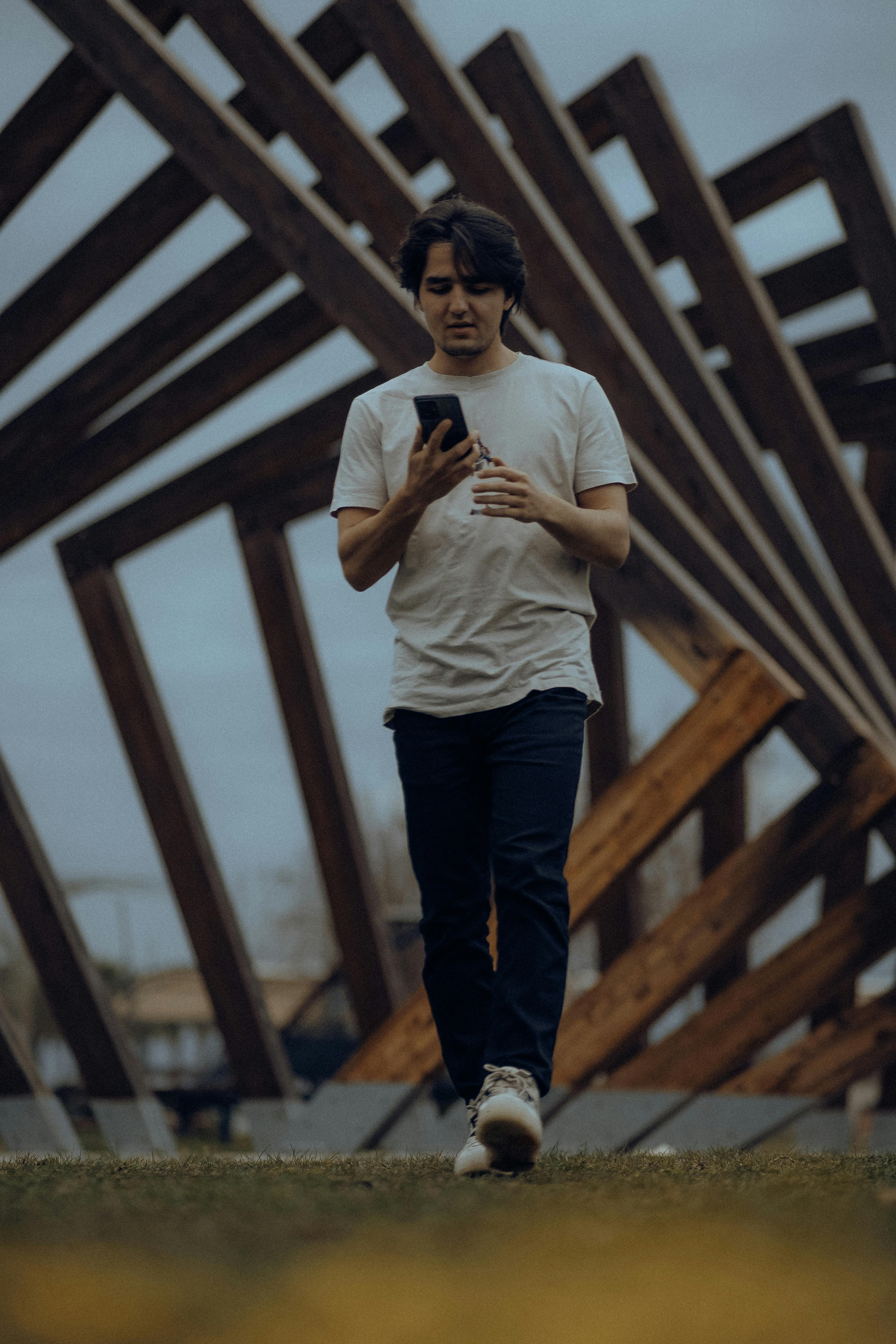 A Man with a Smart Phone Walking By a Blakehope Nick, The Kielder ...