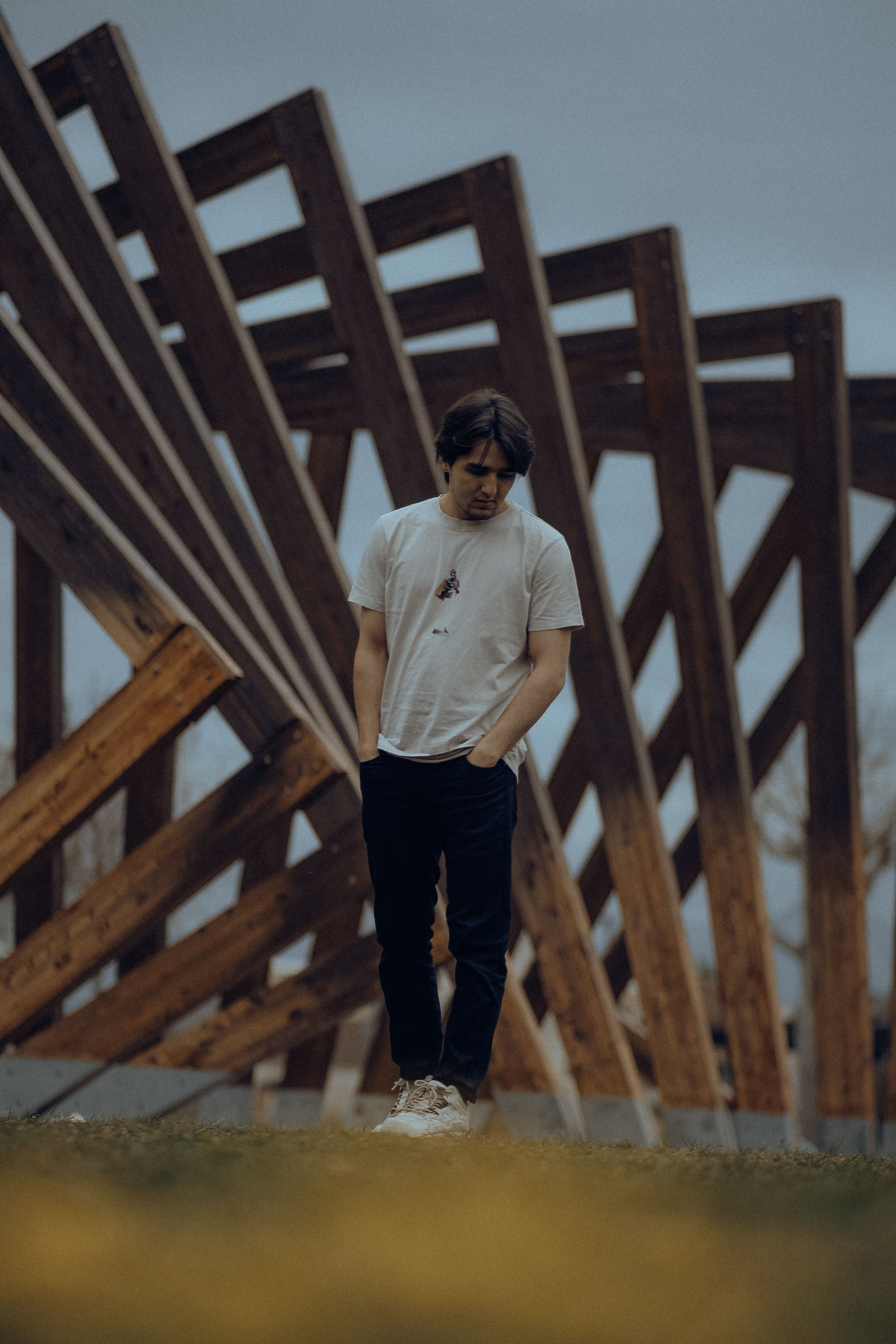 Man Standing against Modern Wooden Rural Structure · Free Stock Photo