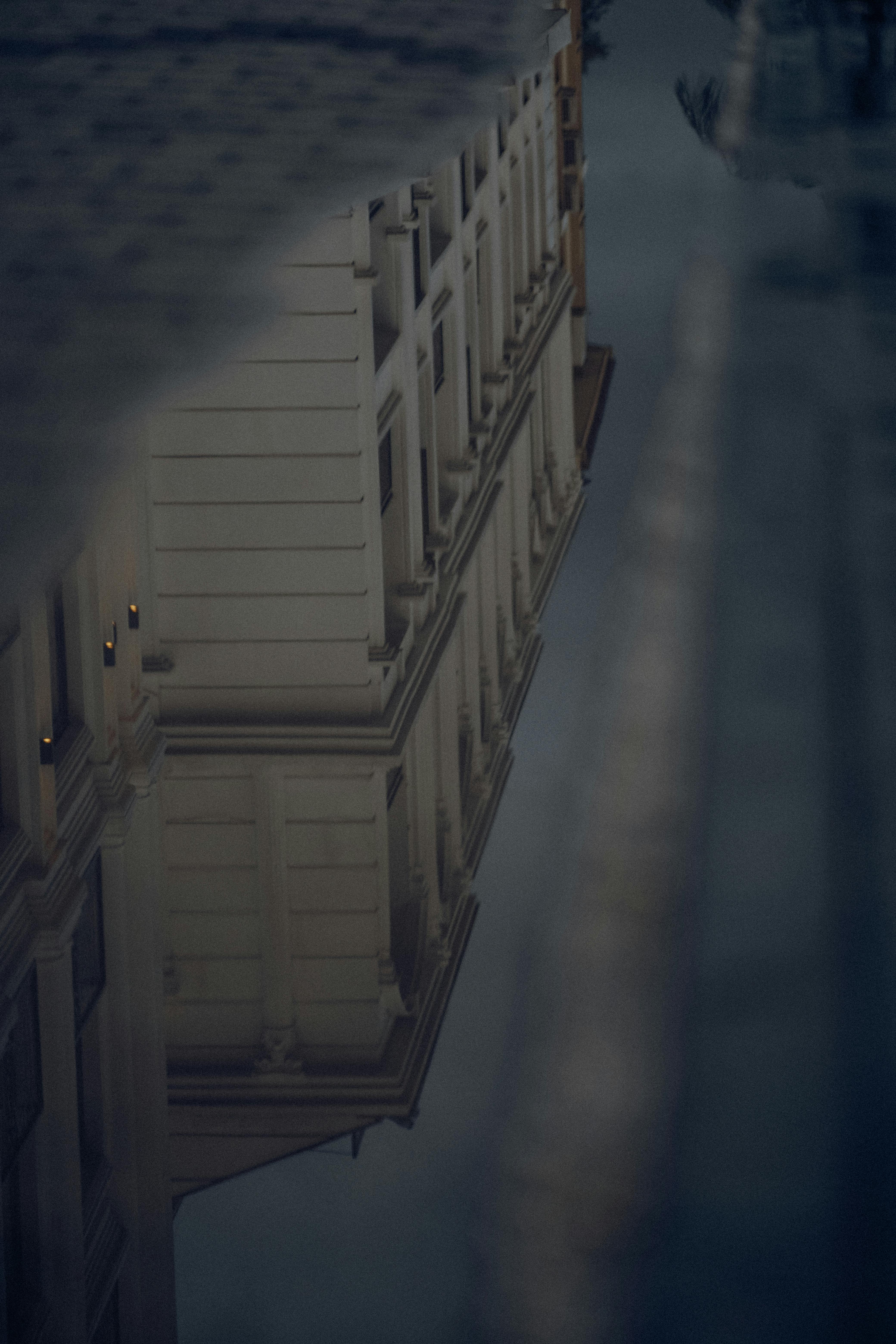 A Classical Building Reflection in a Puddle · Free Stock Photo