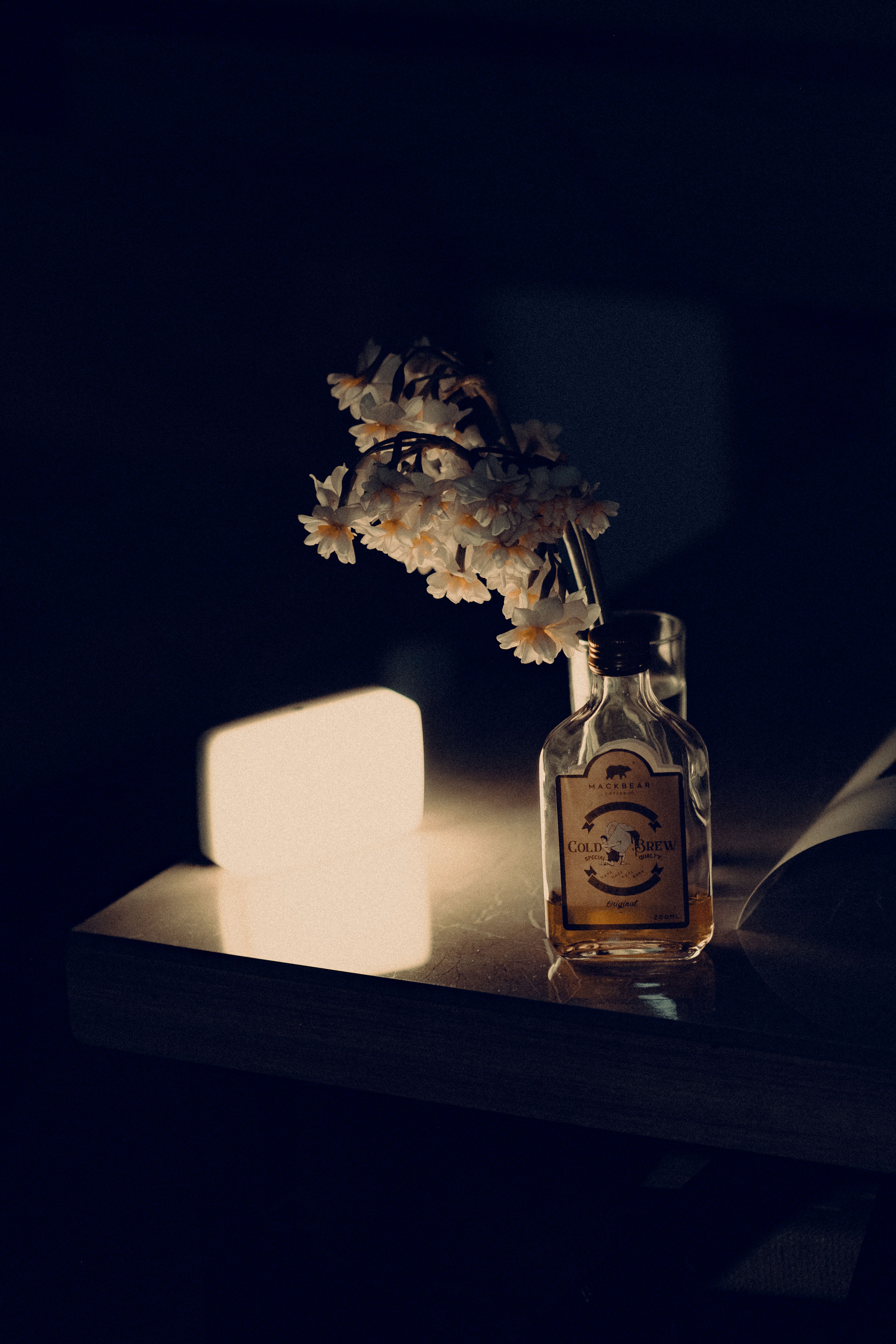 Light over Vial and Flowers · Free Stock Photo