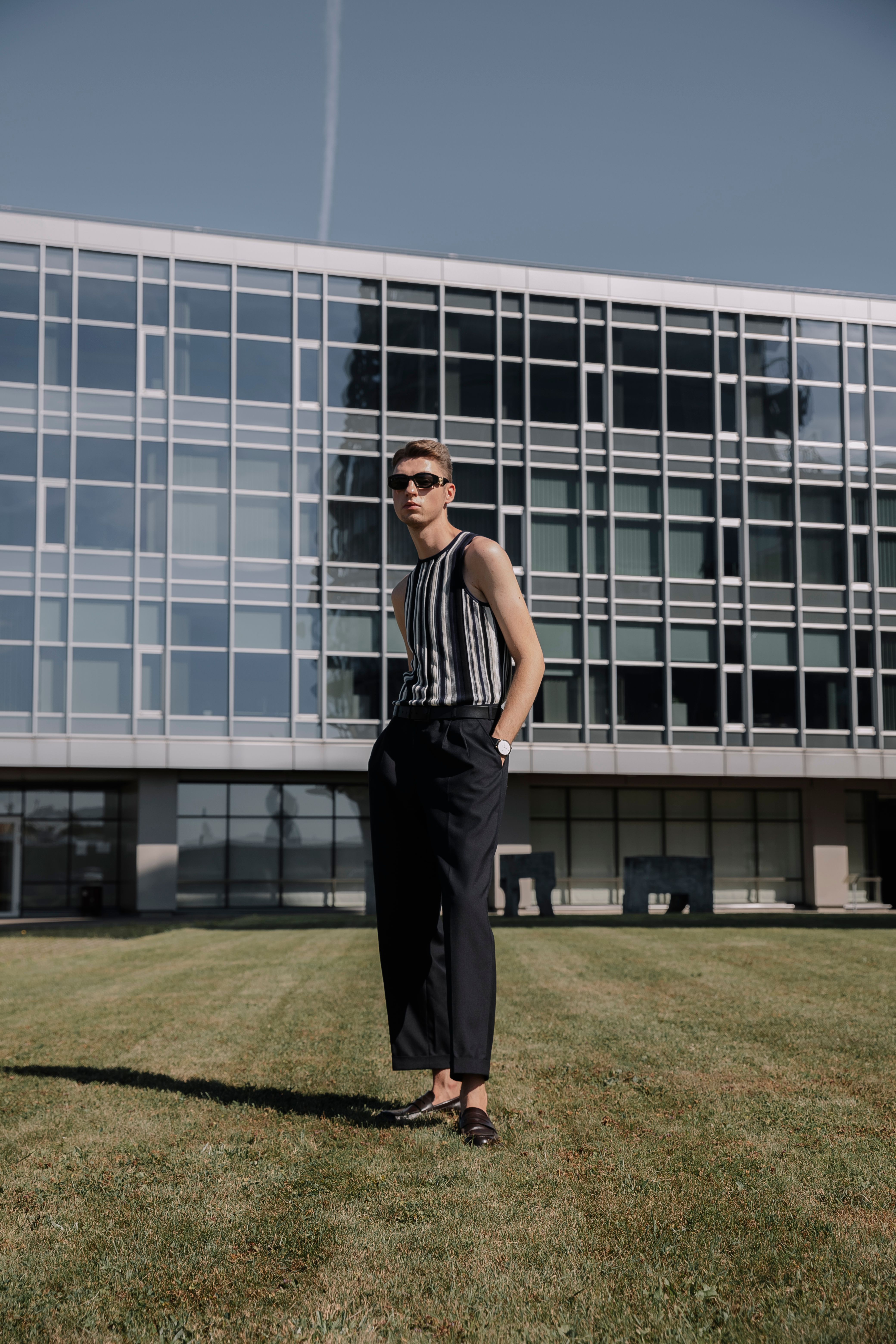 Man Standing in front of a Modern Building · Free Stock Photo