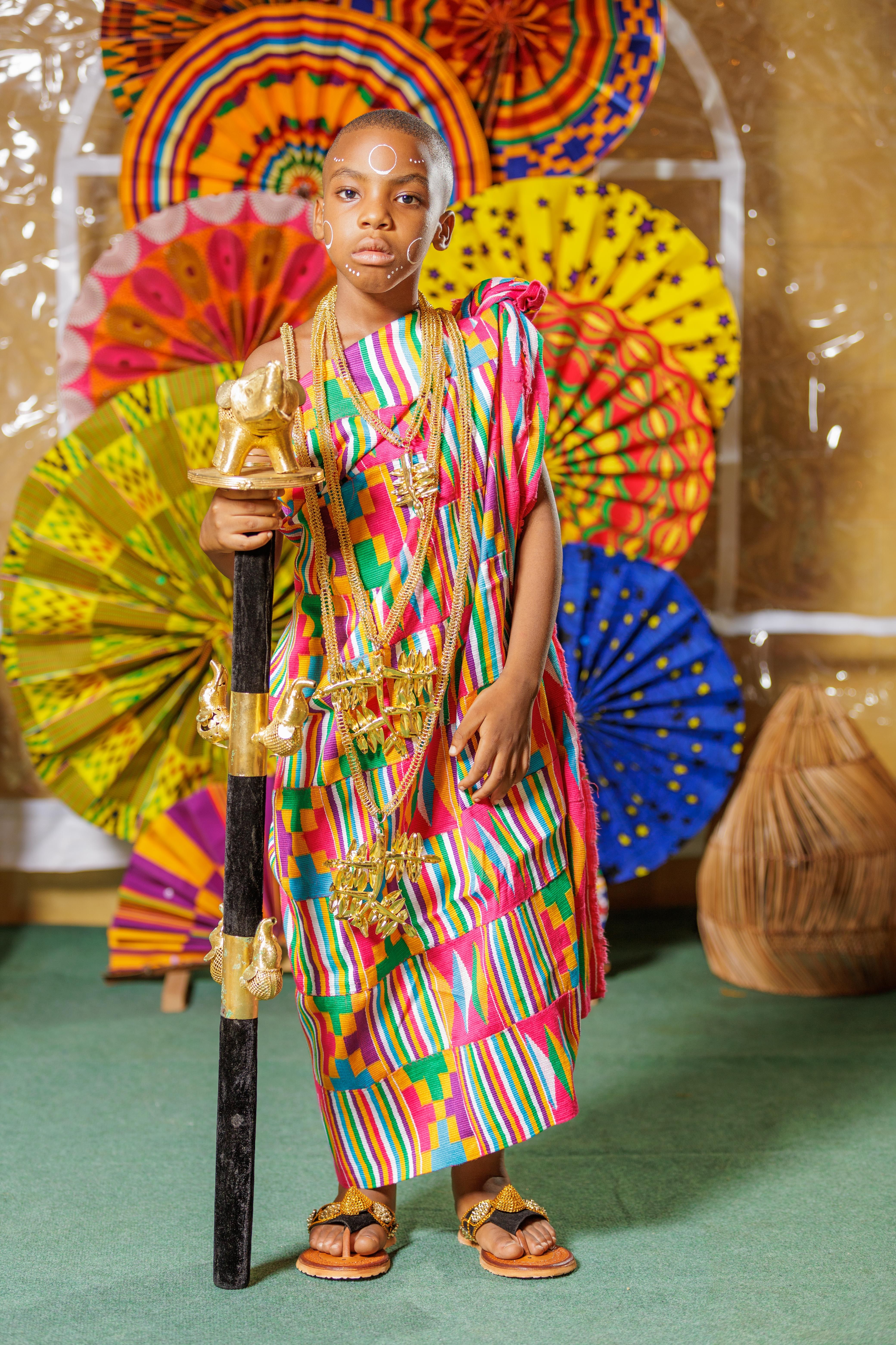 A Boy Wearing a Traditional Colorful Gown · Free Stock Photo