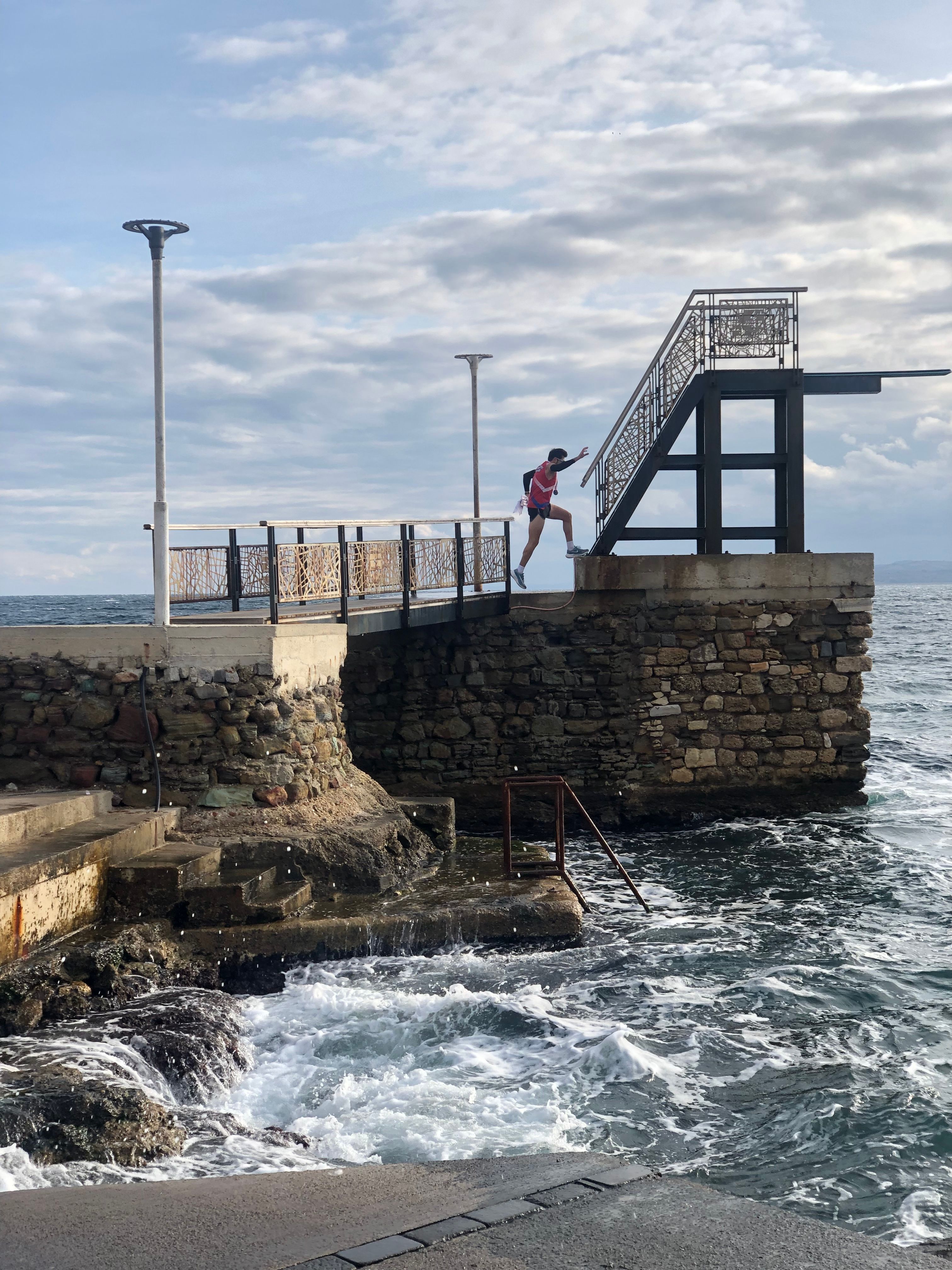 Man Jumping on Stairs on Sea Shore · Free Stock Photo