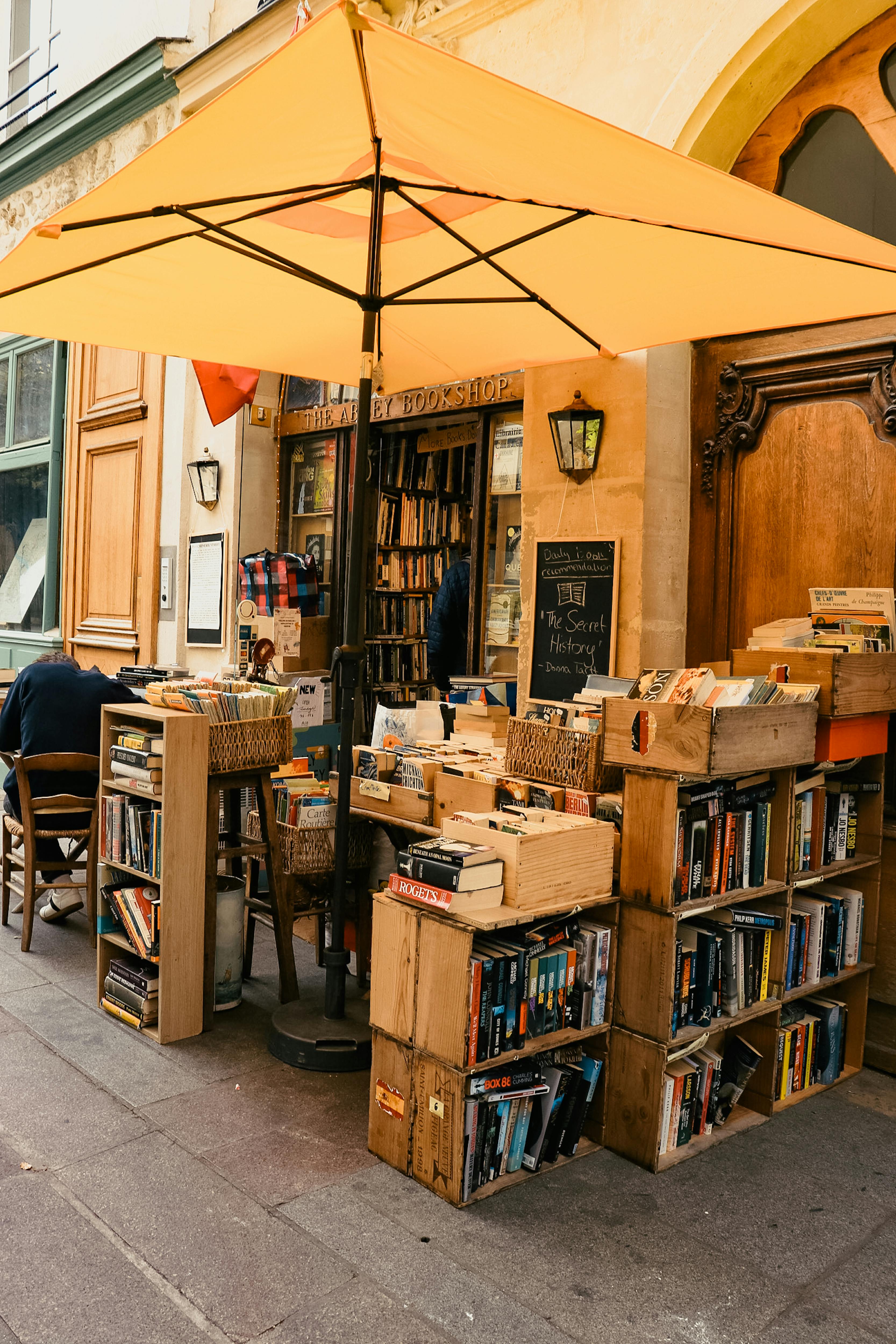A book store with an umbrella and books on the sidewalk · Free Stock Photo