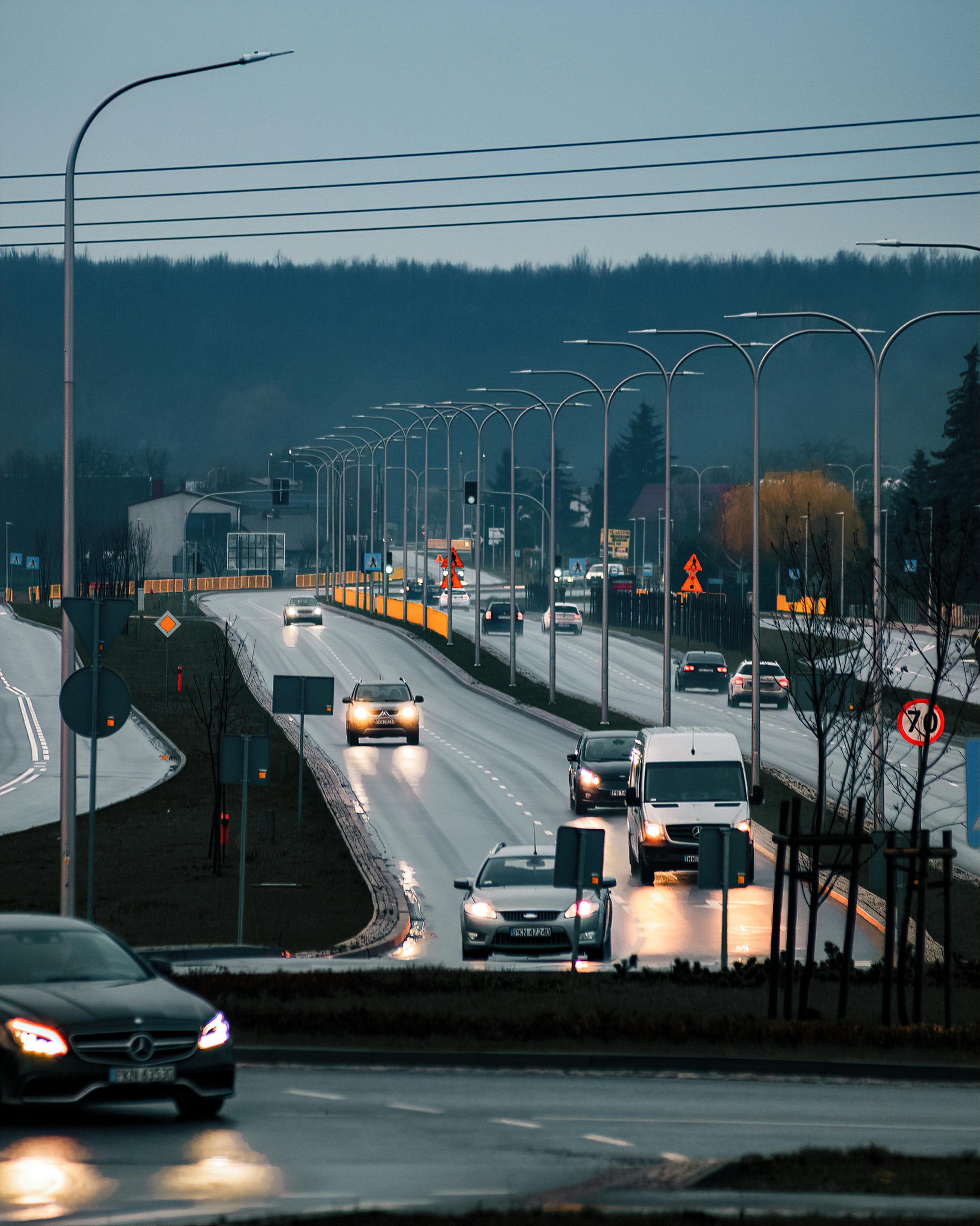 View of Cars on a Street in City Driving at Dusk · Free Stock Photo