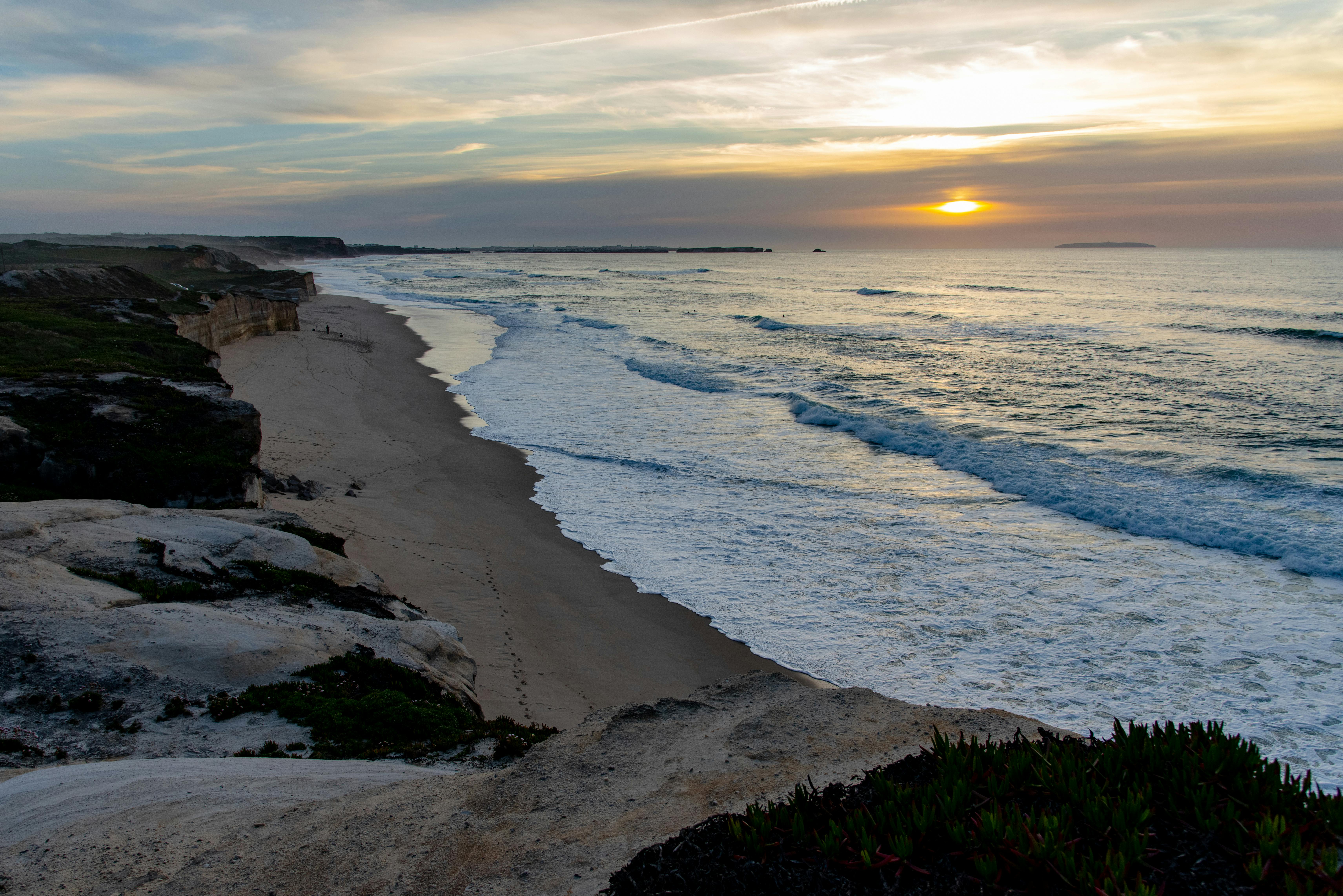 View of Cliffs, Beach and Sea at Sunset · Free Stock Photo
