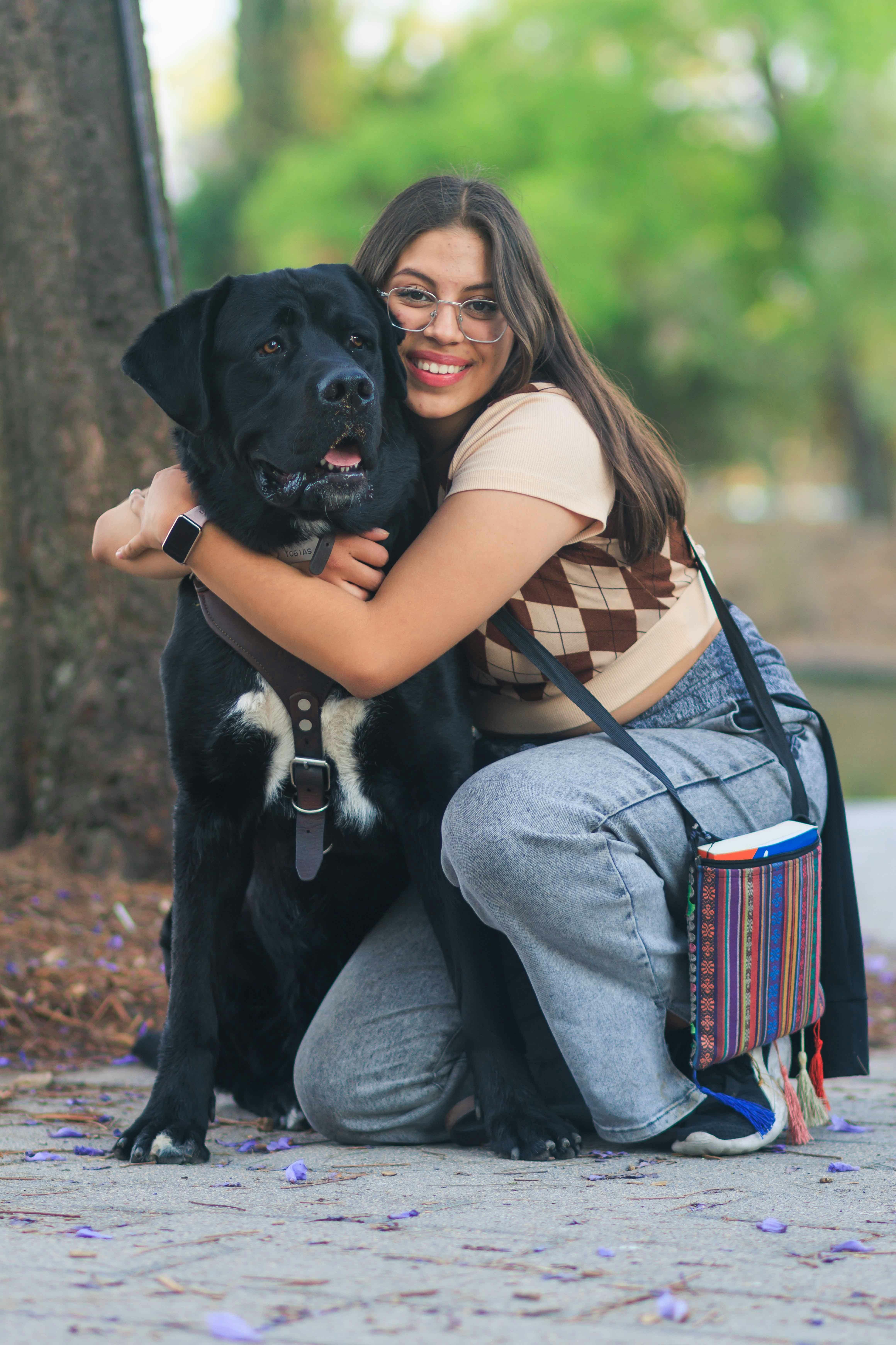 Portrait of a Young Brunette Embracing her Dog · Free Stock Photo