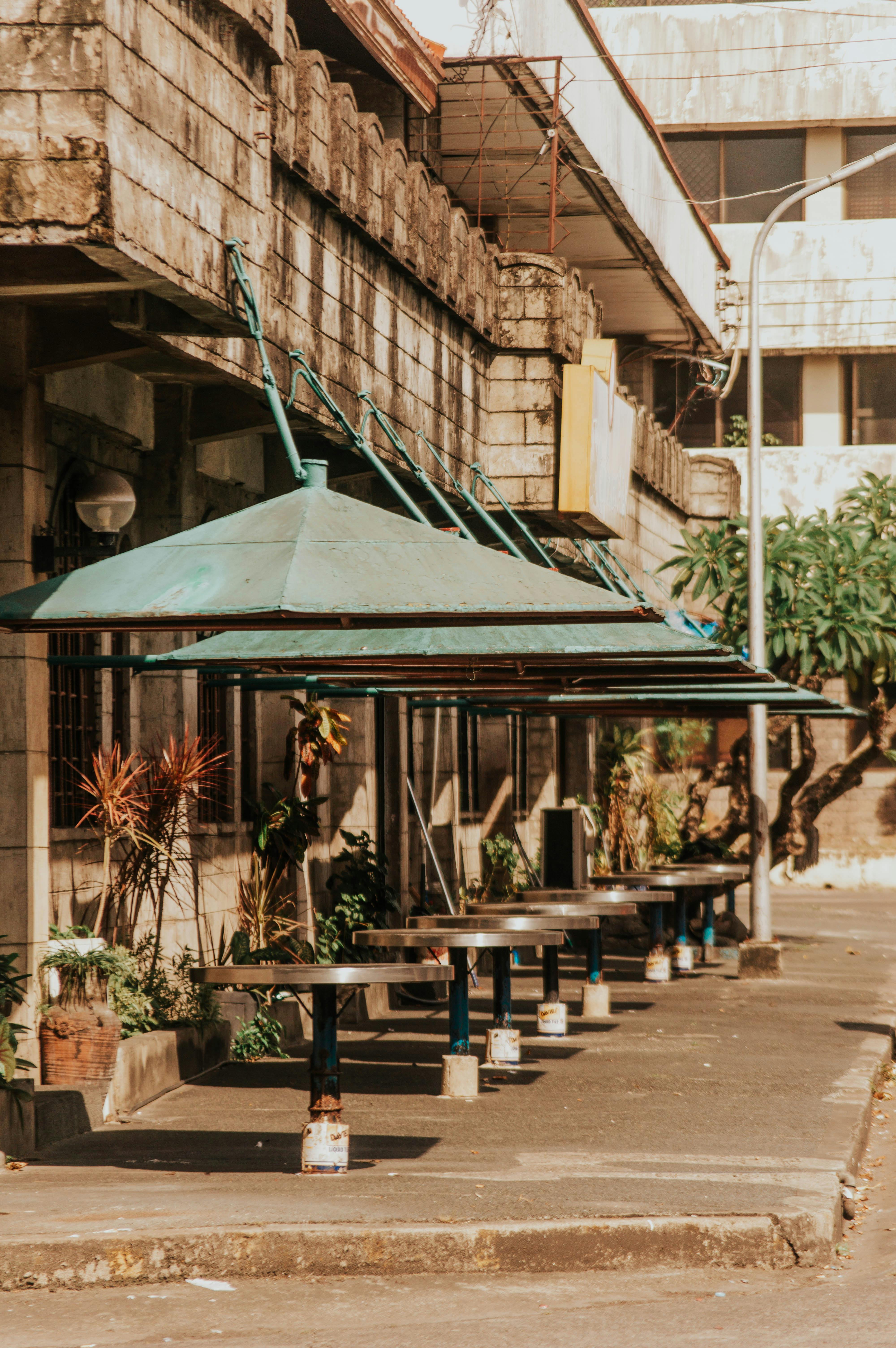 Roofed Cafe Tables · Free Stock Photo