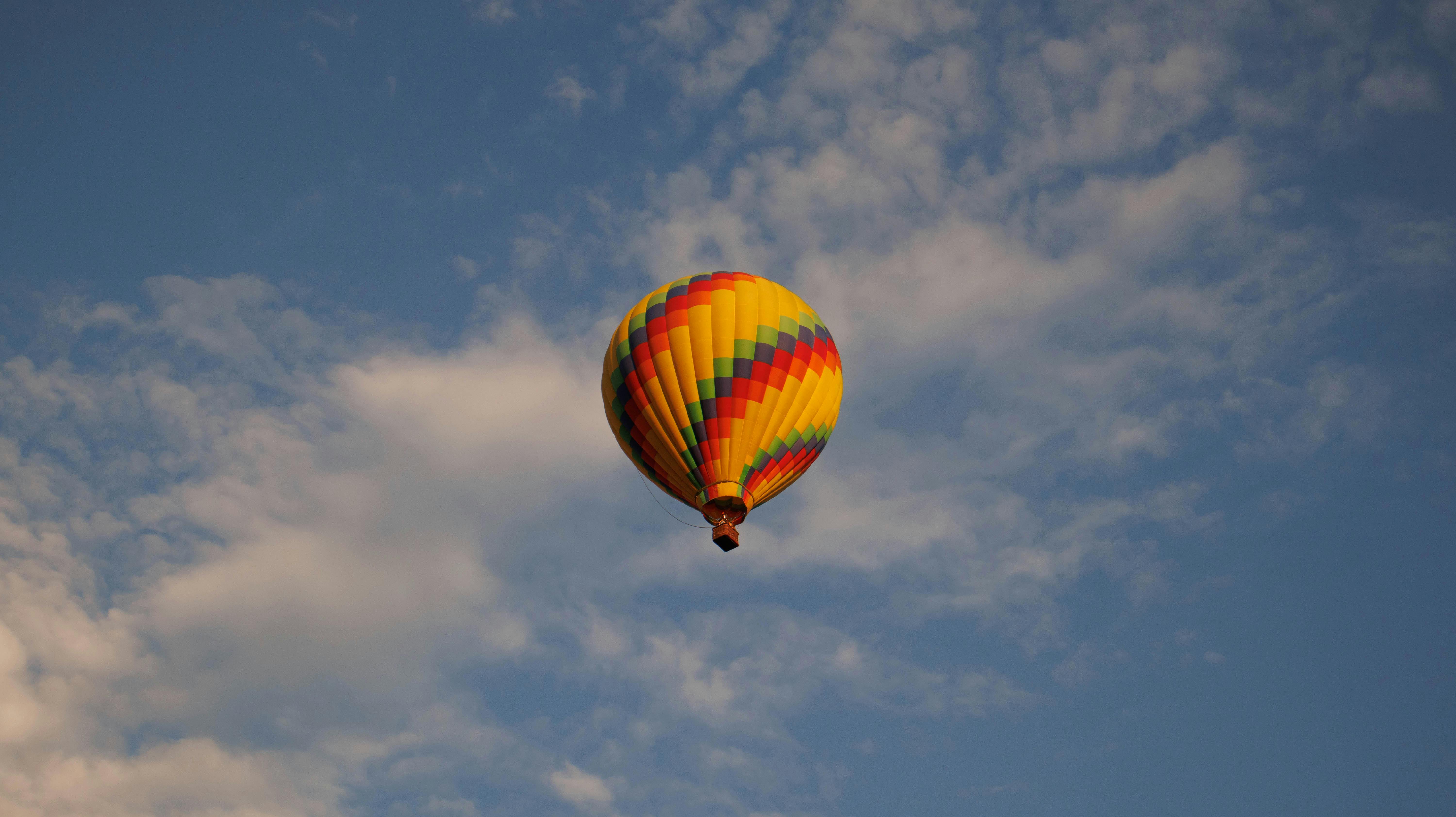 Hot Air Balloon Flying Under Blue Sky during Daytime · Free Stock Photo