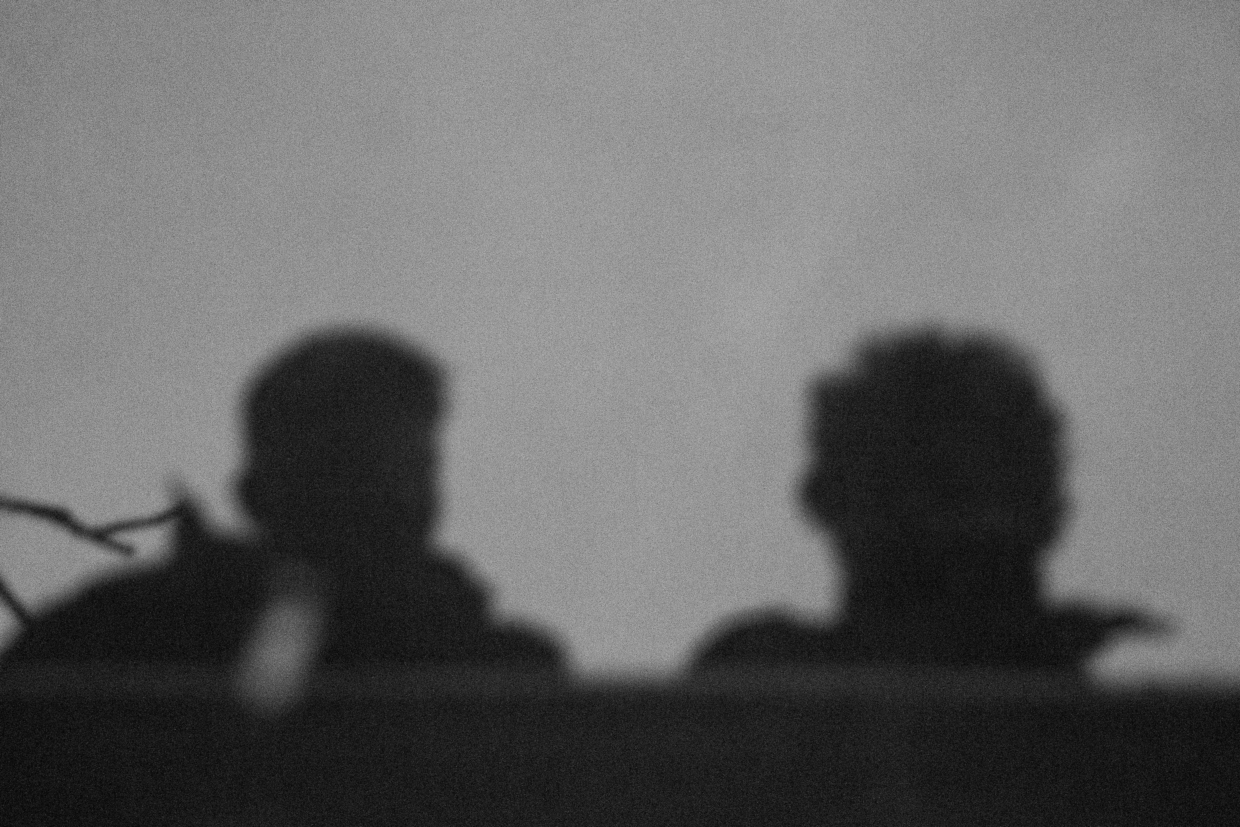 Shadows of Men on Wall Surface · Free Stock Photo