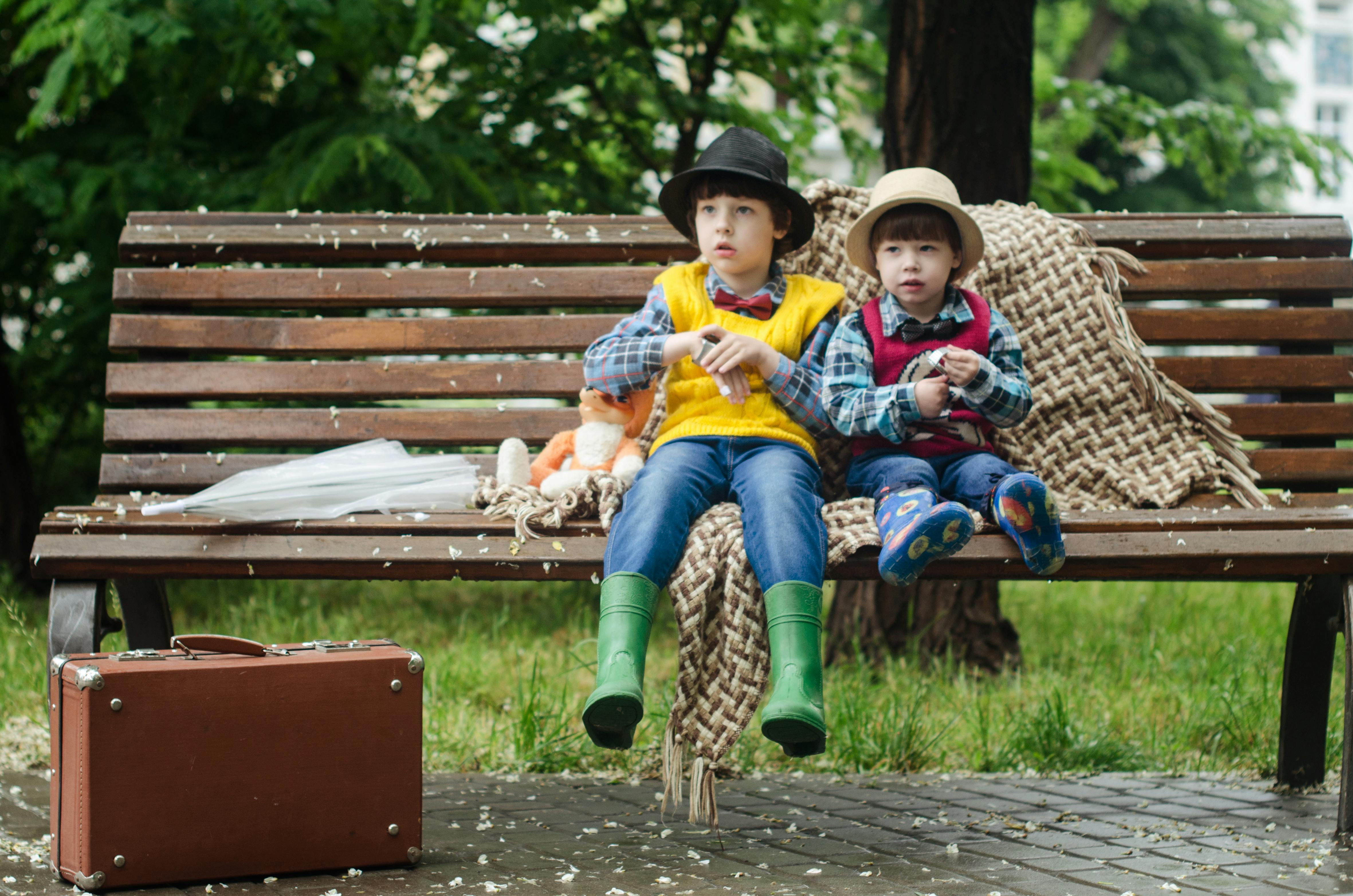 Two Kids Sitting on a Red Bench · Free Stock Photo