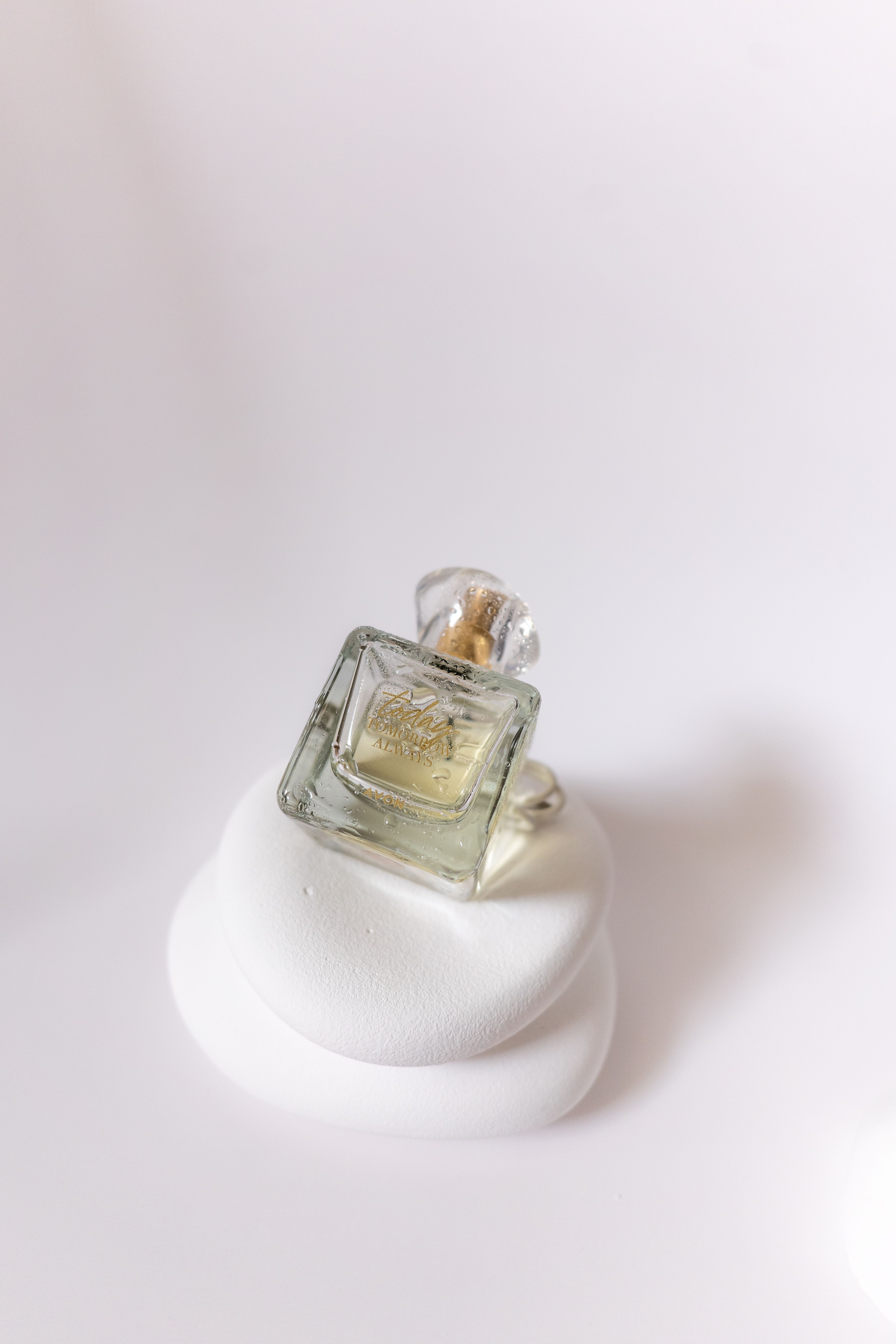 Vial of Perfume on White Fabric · Free Stock Photo