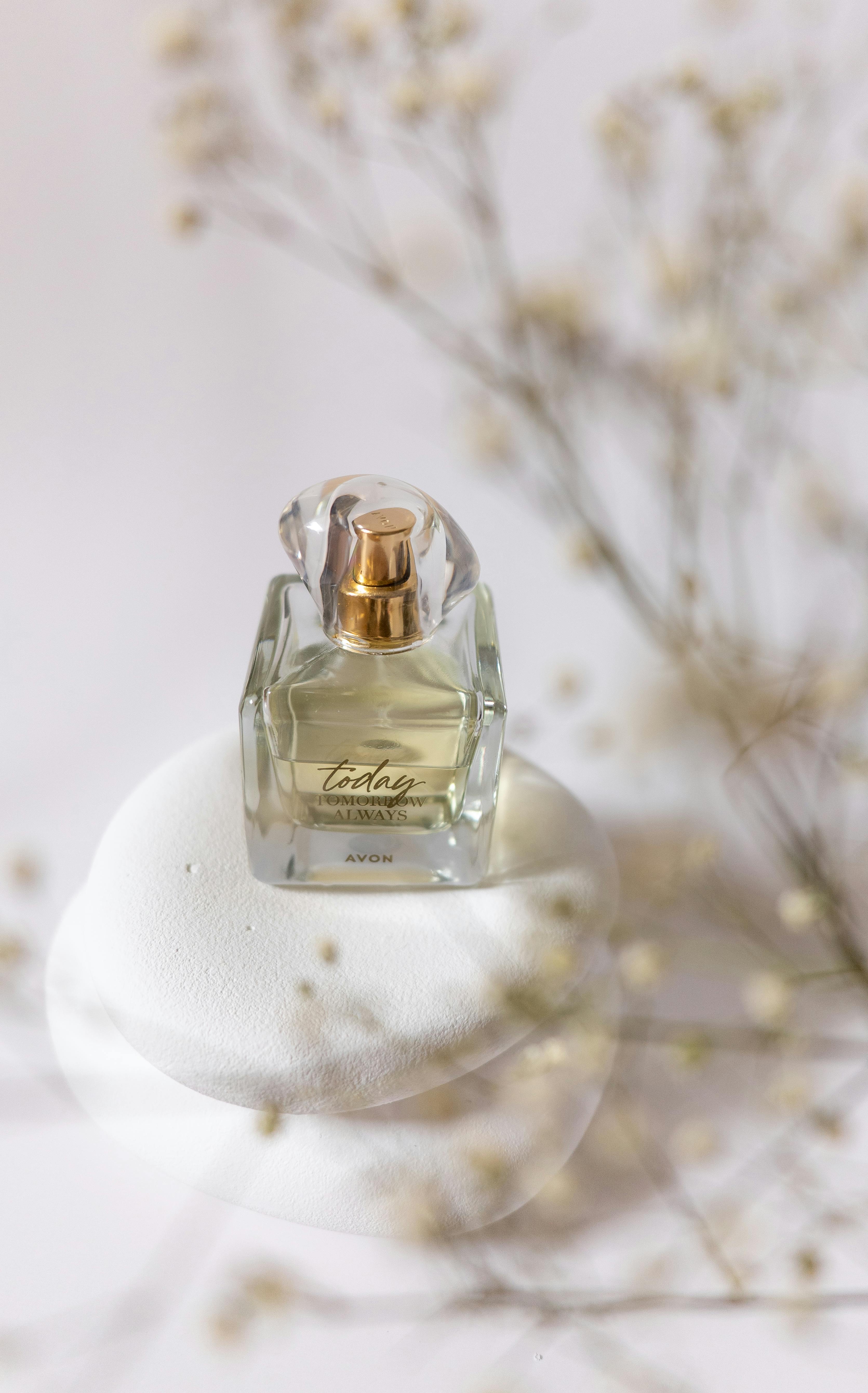 Close up of Perfume Vial behind Plant Branches · Free Stock Photo