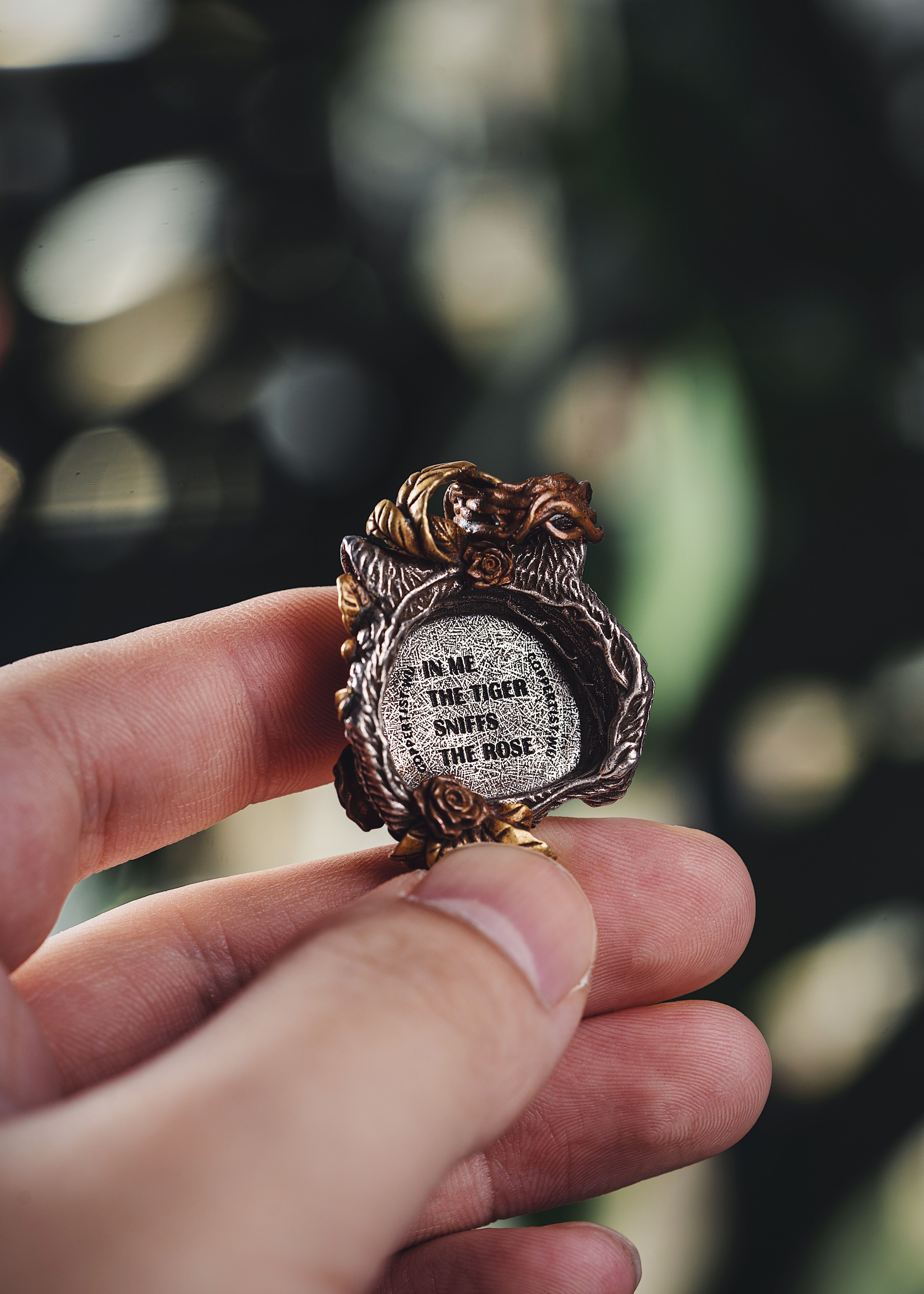Cloe-up of a Person Holding a Pendant with a Quote · Free Stock Photo