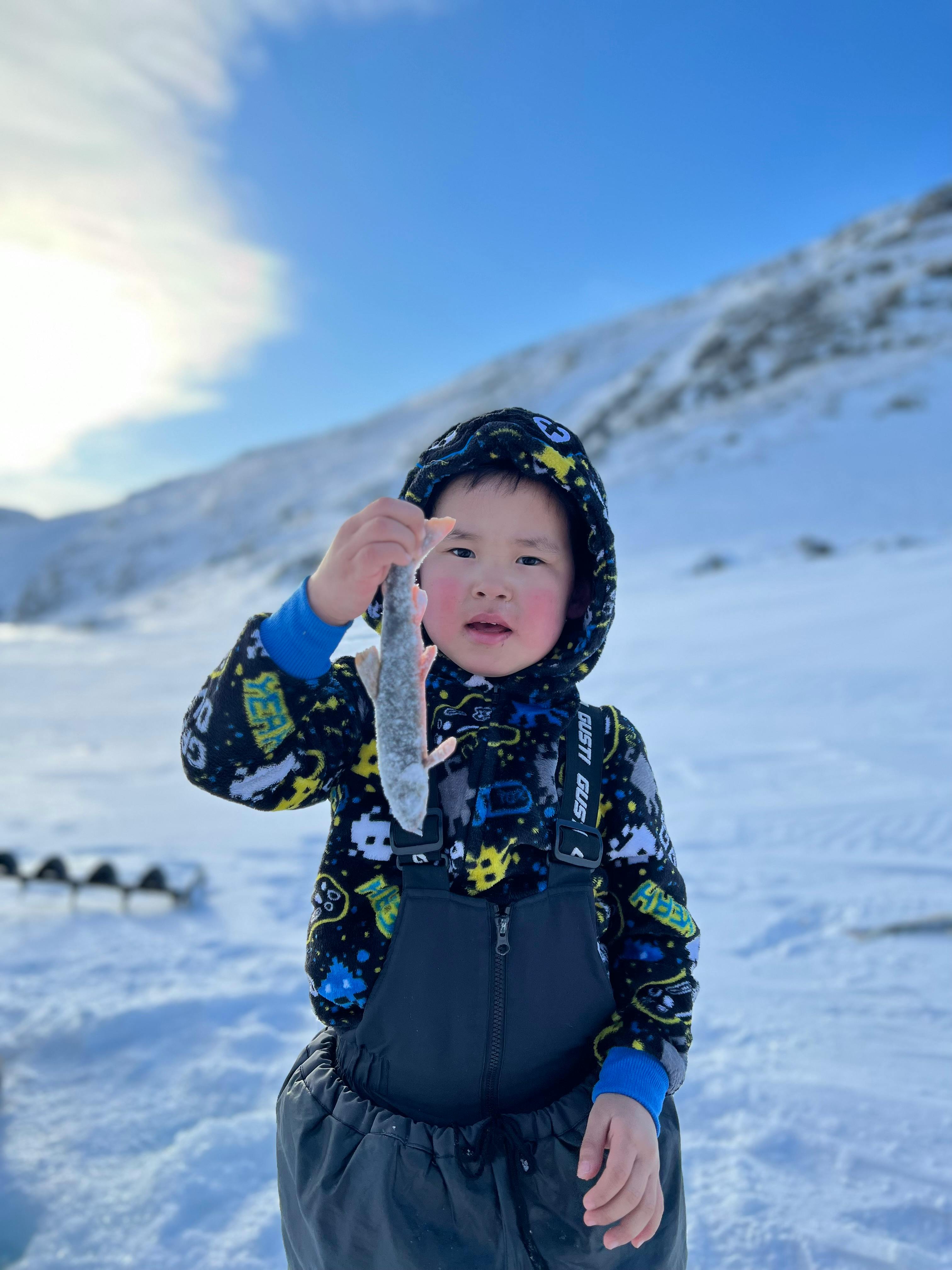 Little Kid Showing Frozen Fish · Free Stock Photo