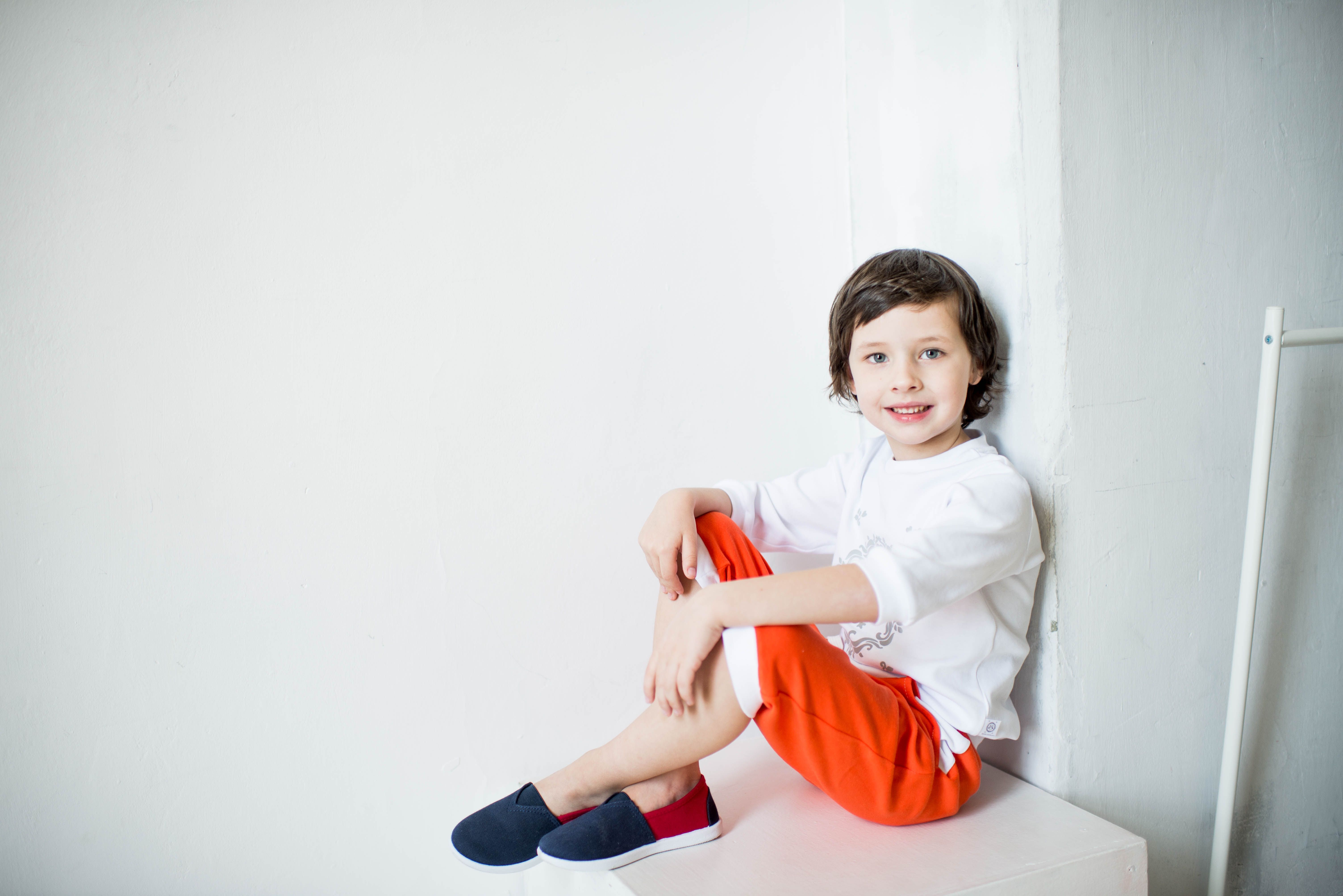 Photo of Smiling Boy Sitting · Free Stock Photo