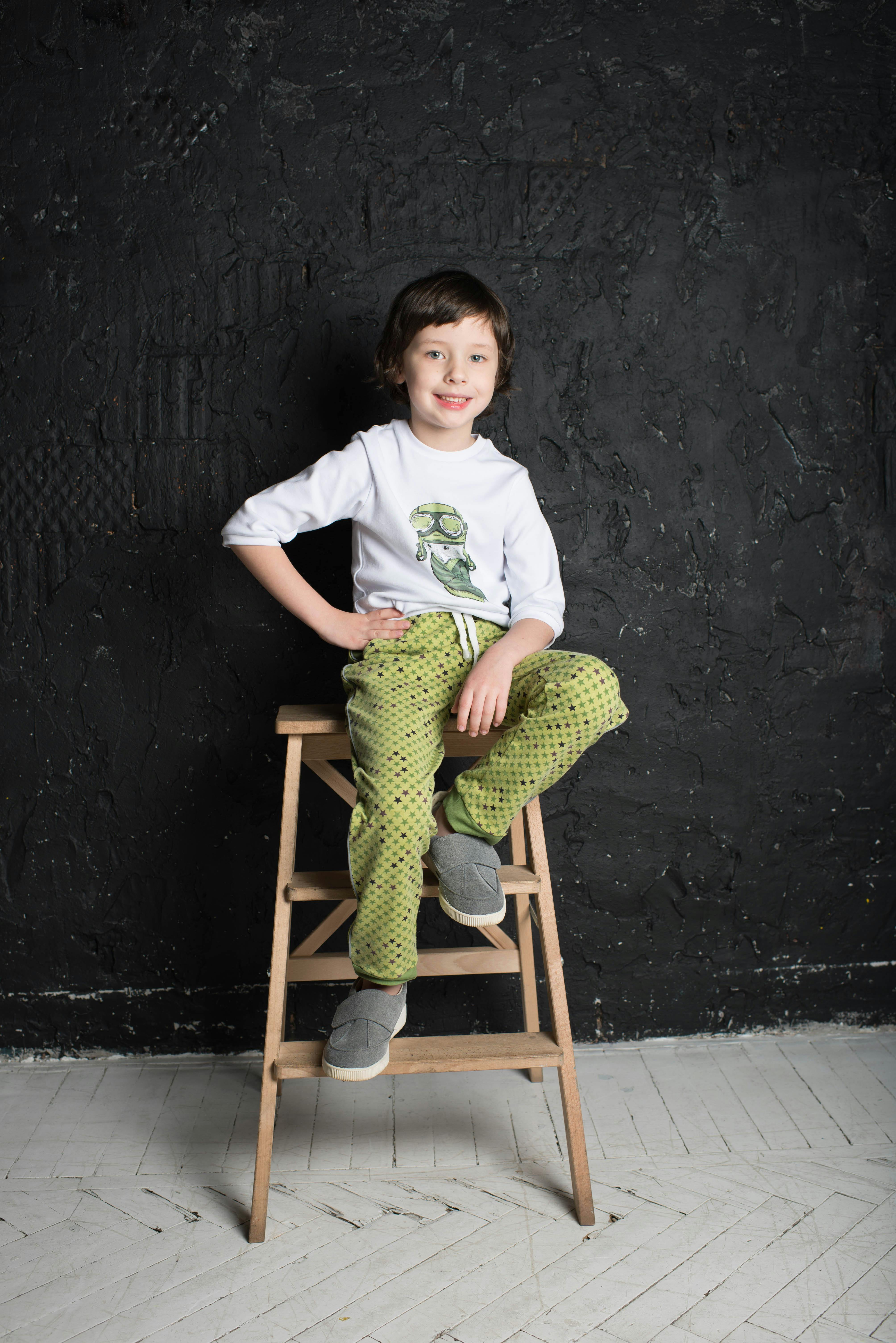 Photo Of Kid Sitting On A Chair · Free Stock Photo