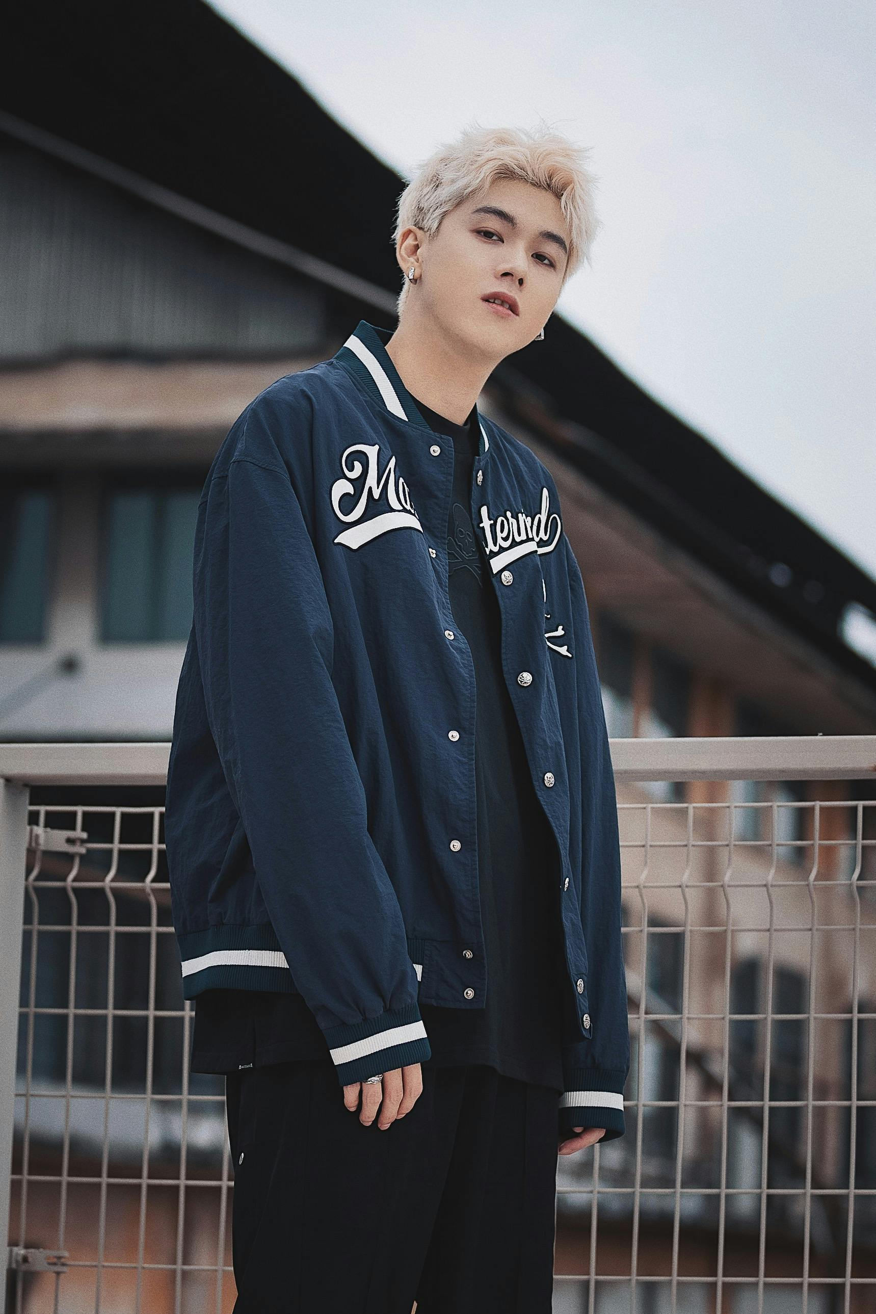 Man in Letter Collage Jacket · Free Stock Photo