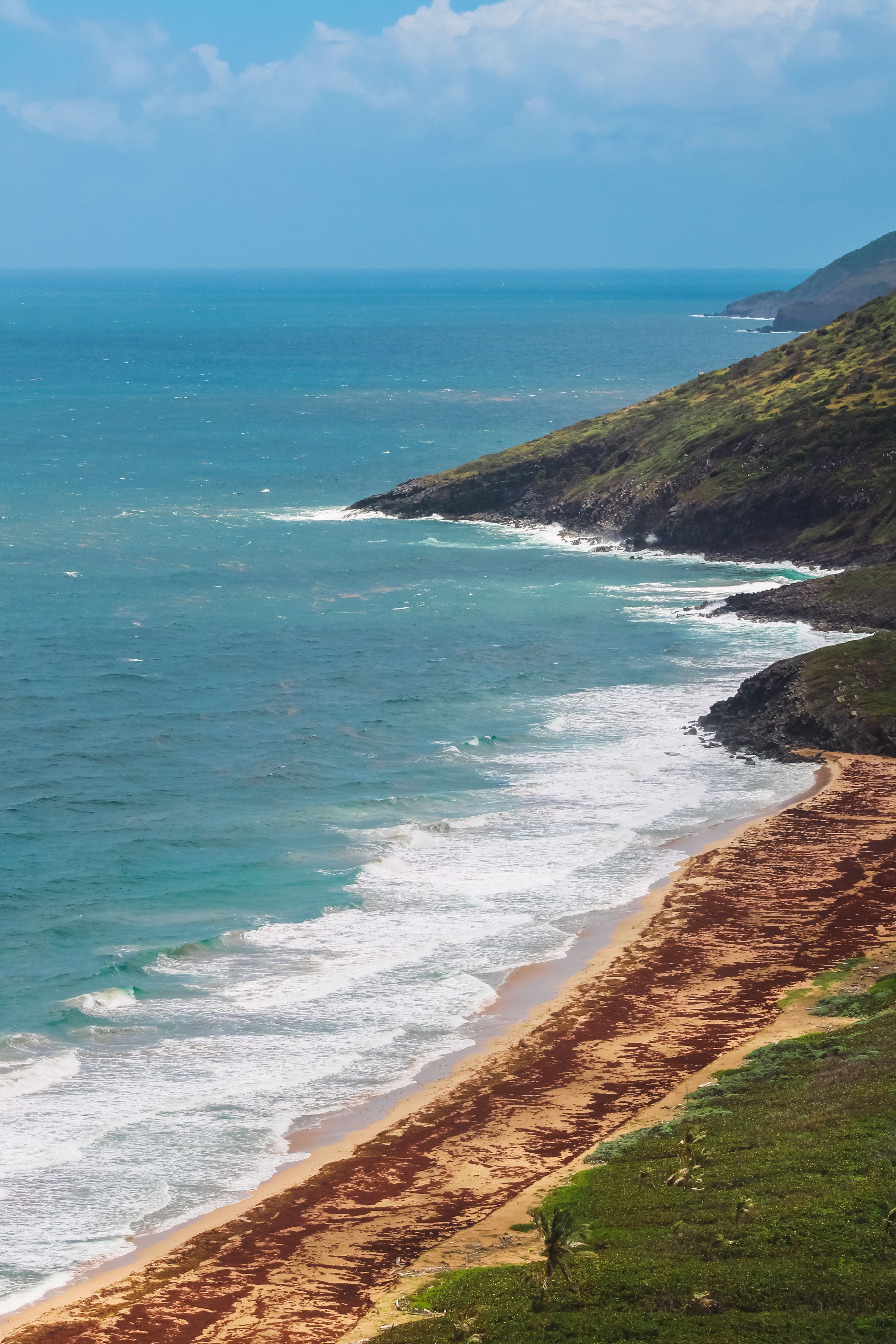 Person on Sea Shore near Cliffs · Free Stock Photo