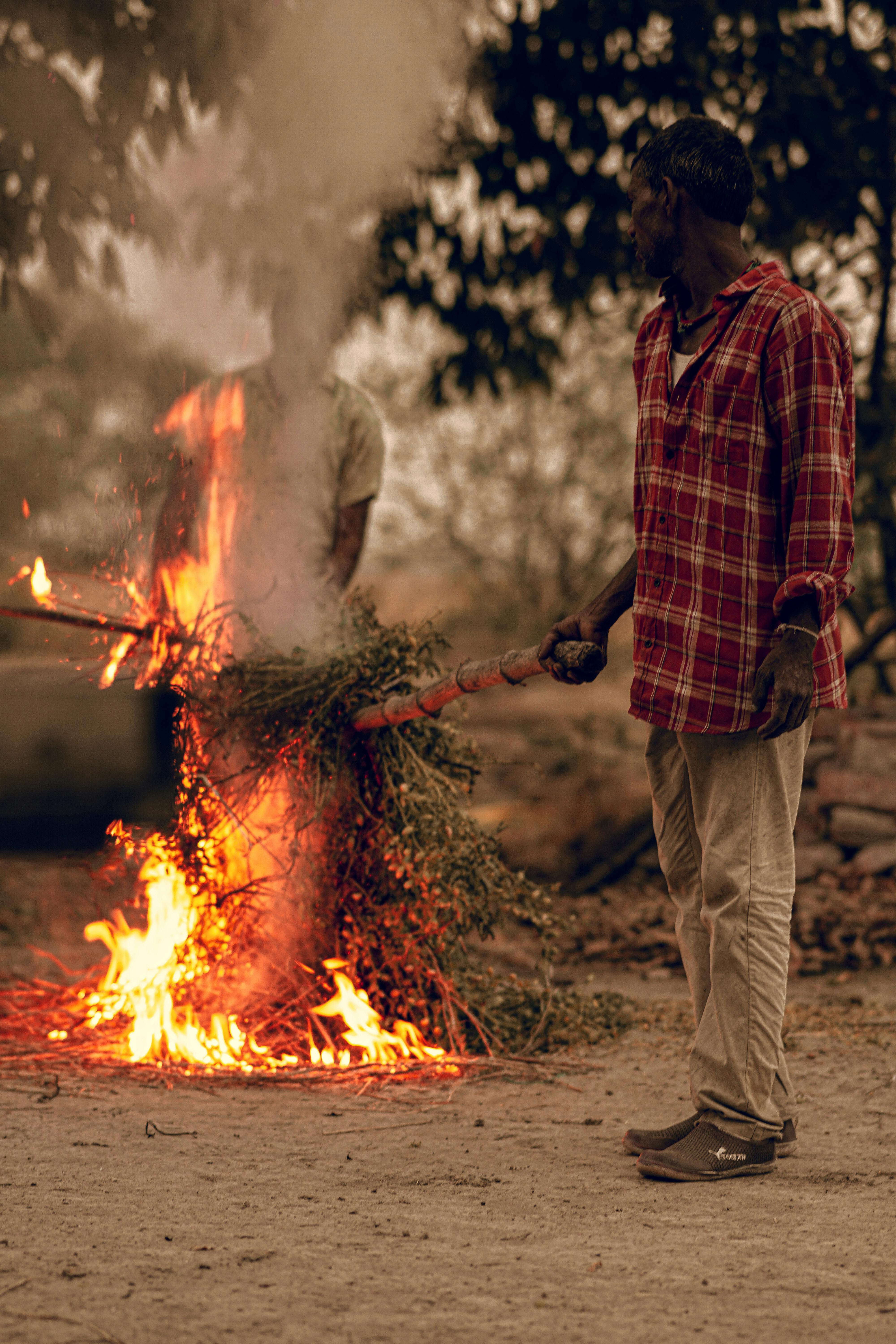 Man Sitting by the Fire on a Desert · Free Stock Photo