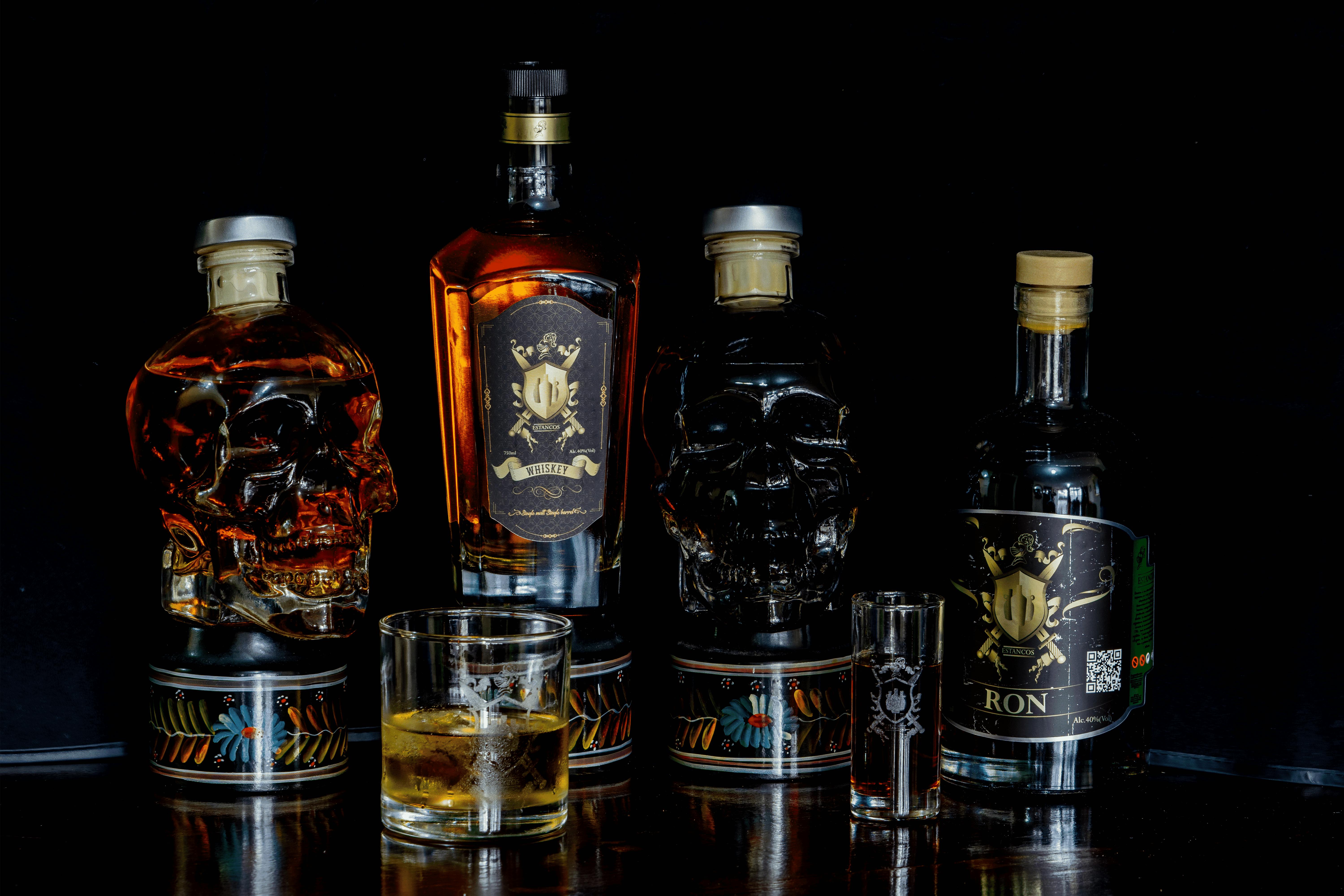 Closeup Photo of Liquor Bottle Against Black Background · Free Stock Photo