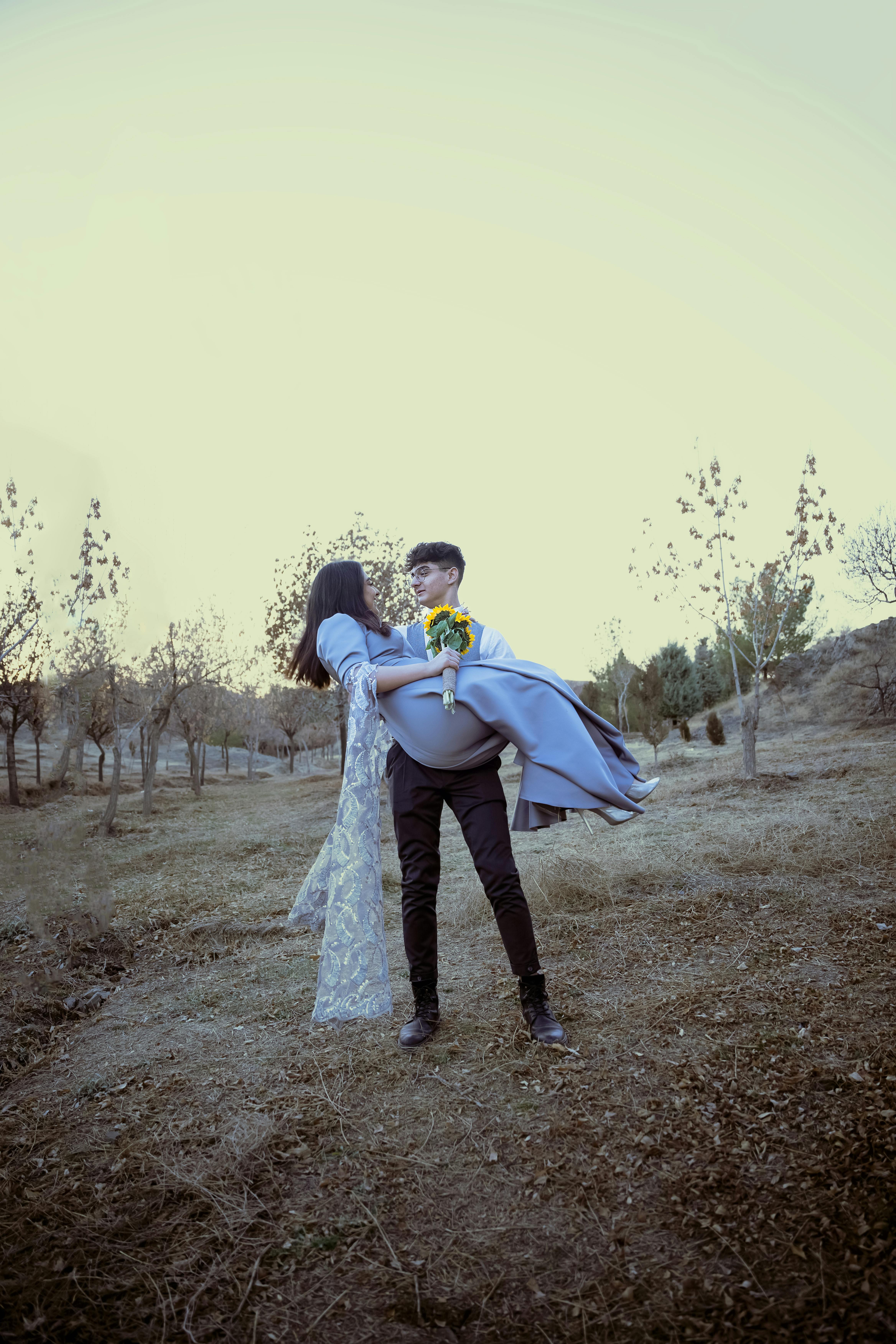 Man Picking up Woman Wearing Blue Dress · Free Stock Photo