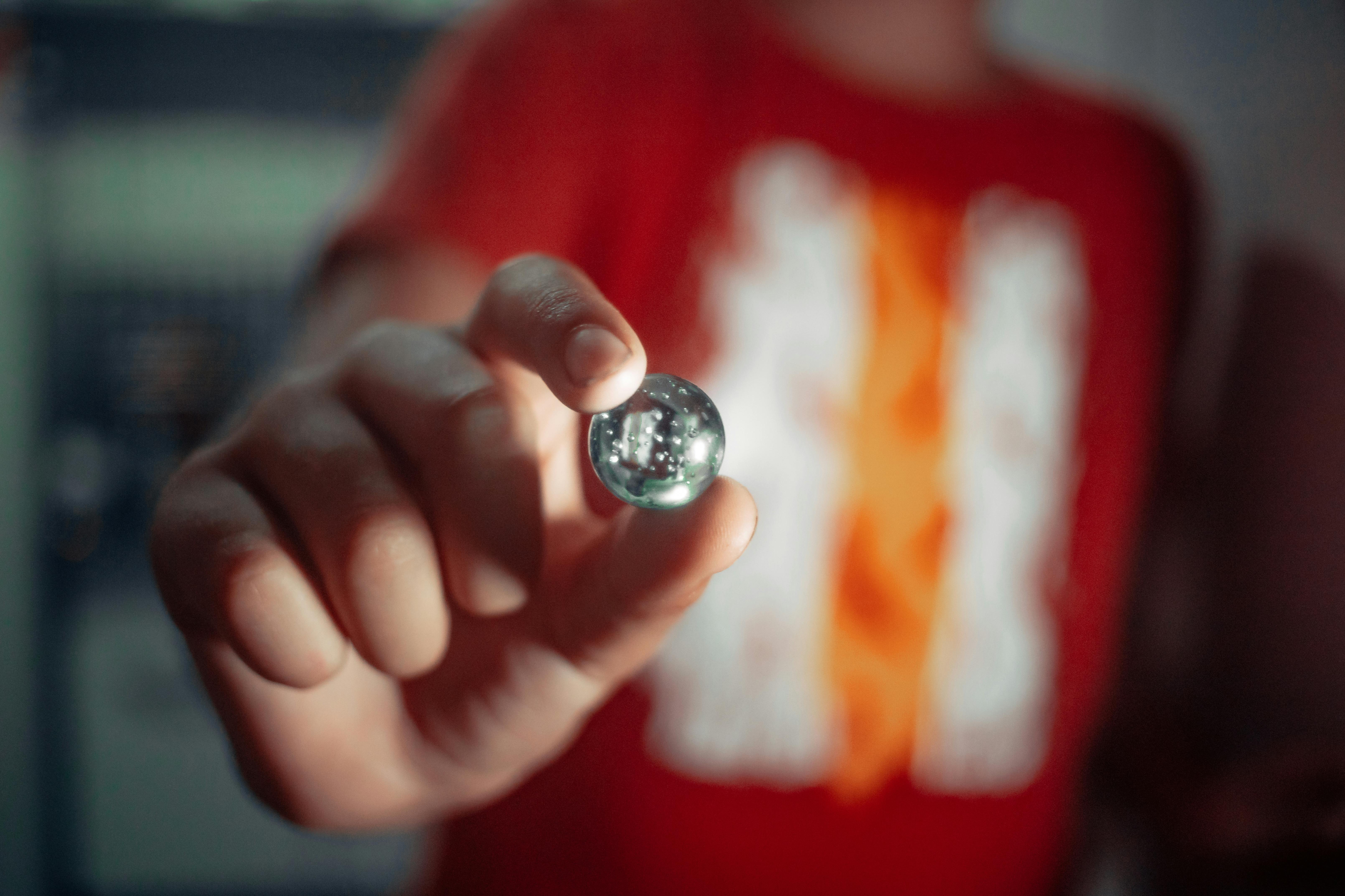 Hand Holding Small, Glass Ball · Free Stock Photo