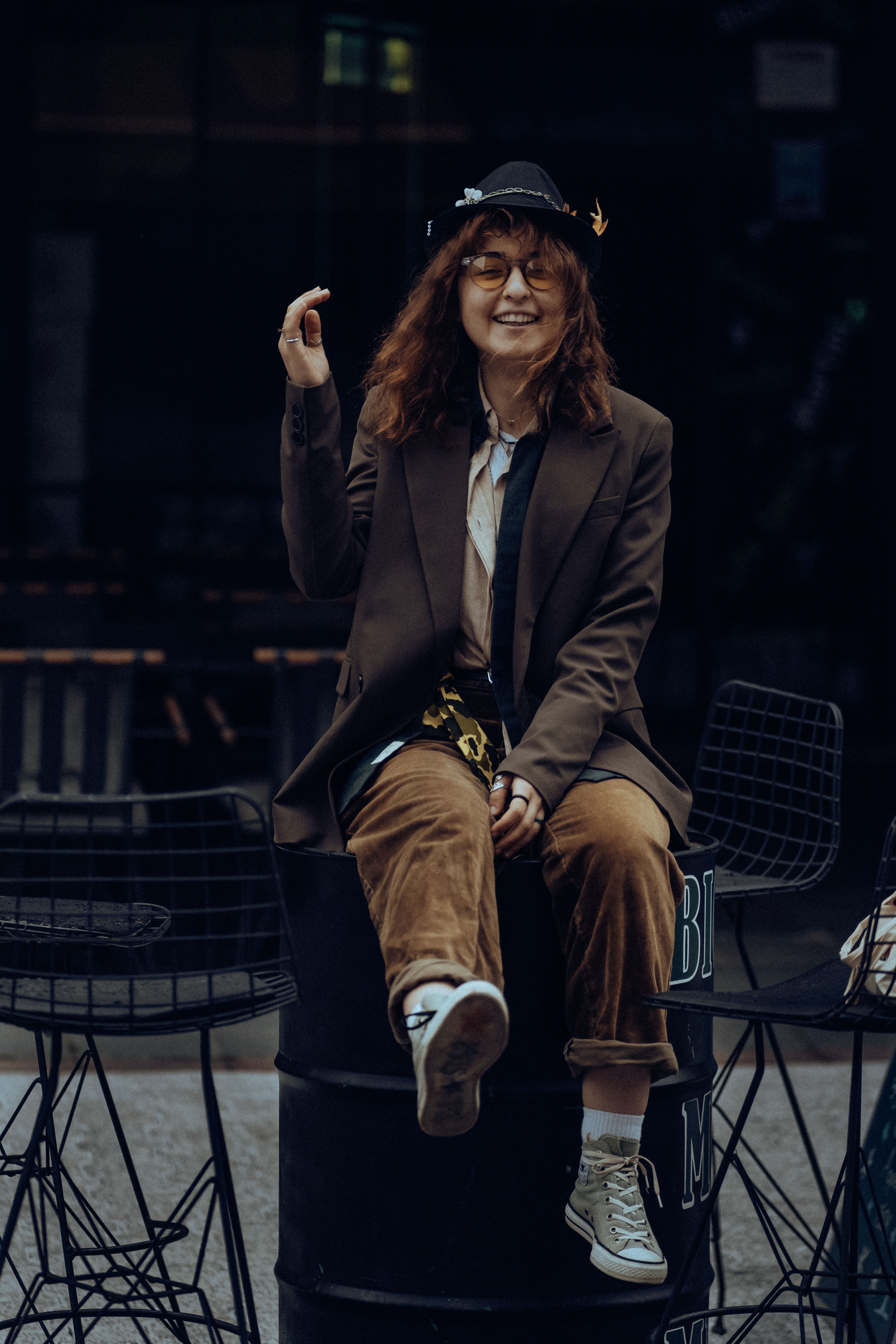 Smiling Woman Sitting on Barrel · Free Stock Photo