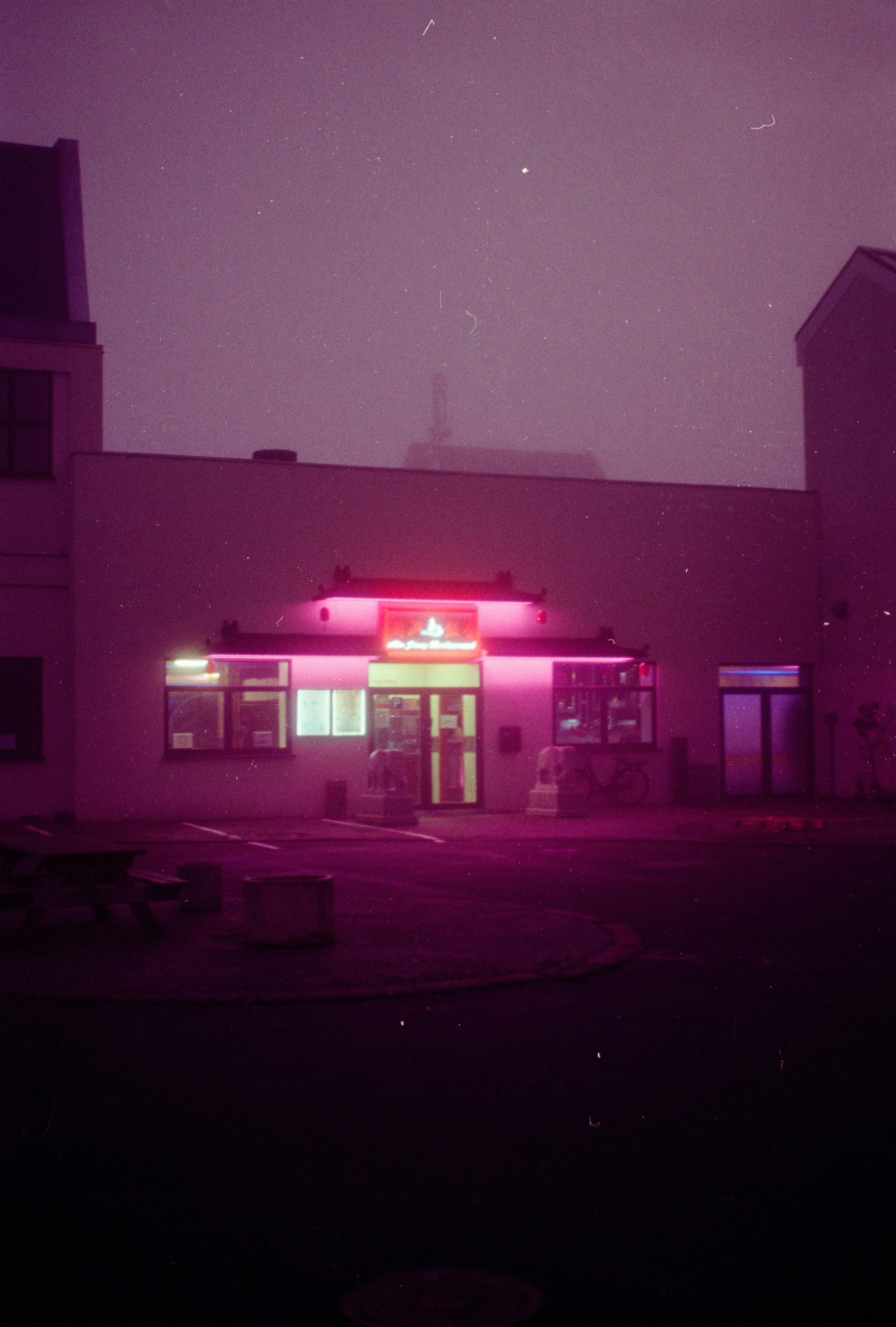 Red Illuminated Store Entrance · Free Stock Photo