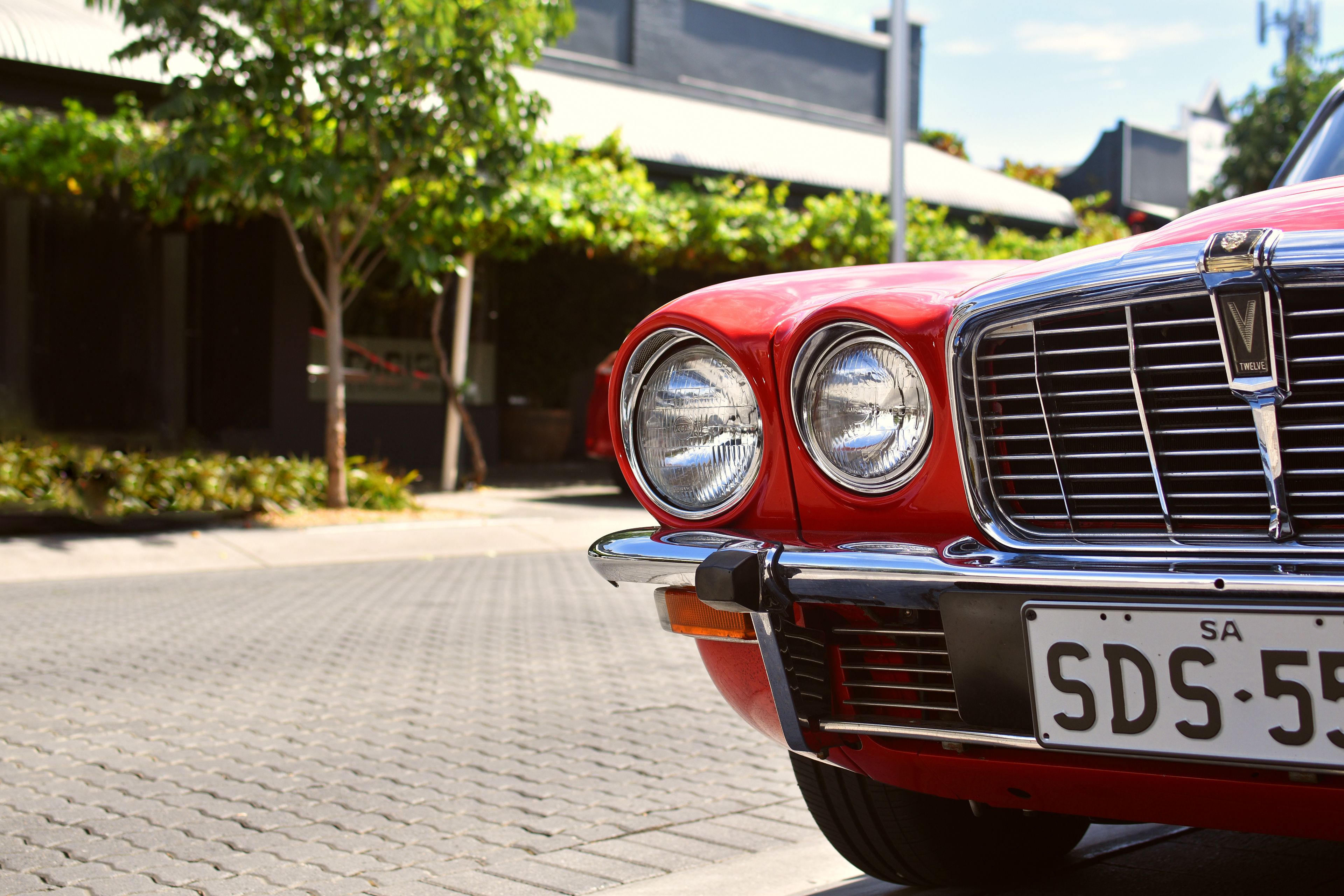 Headlights of Red Jaguar XJ6 · Free Stock Photo